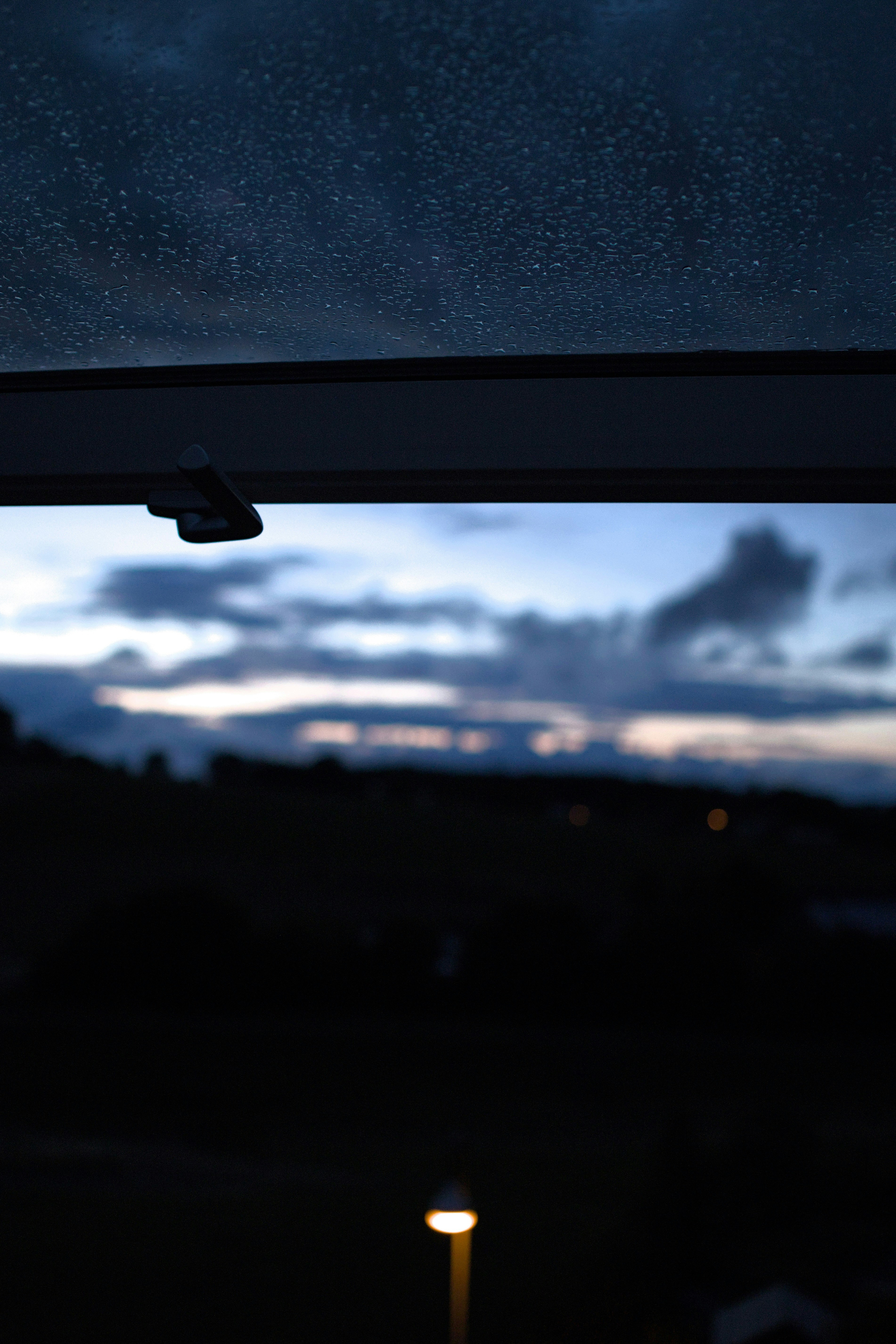 Night Sky Through a Damp Window: City Lights and Quiet Horizon
