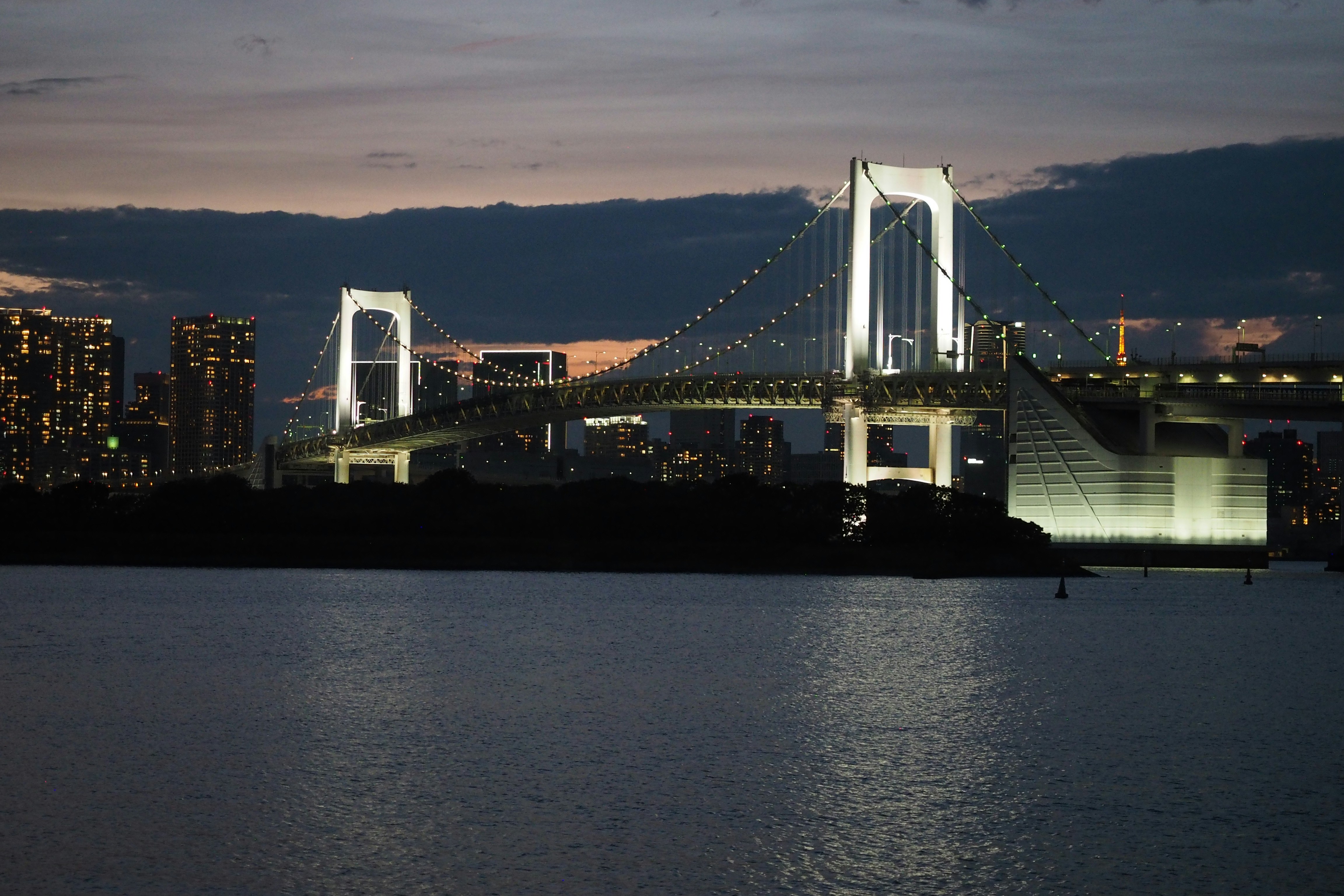 Night skyline bridge: illuminated spans across calm water