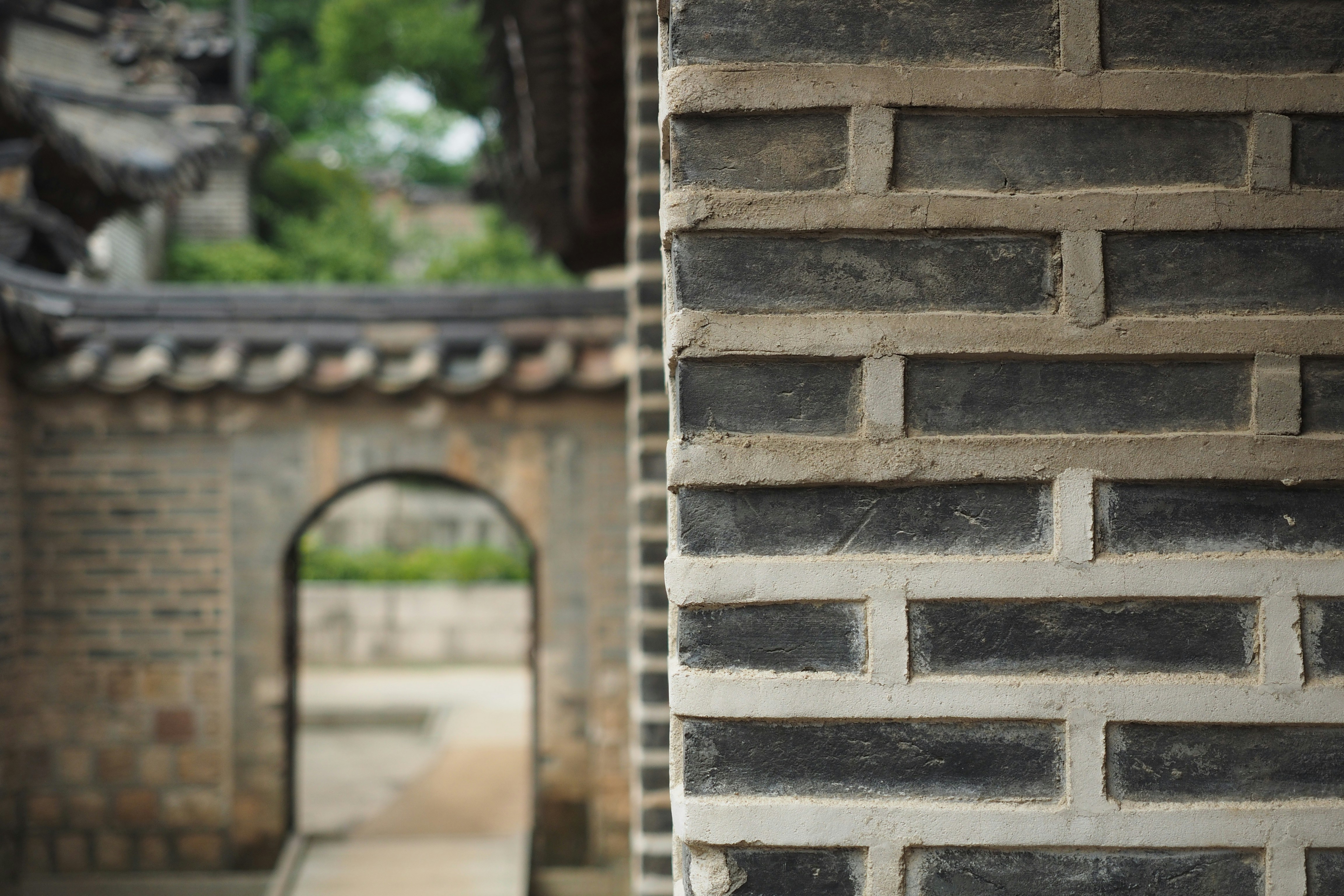 Hidden Gateways Between Weathered Bricks
