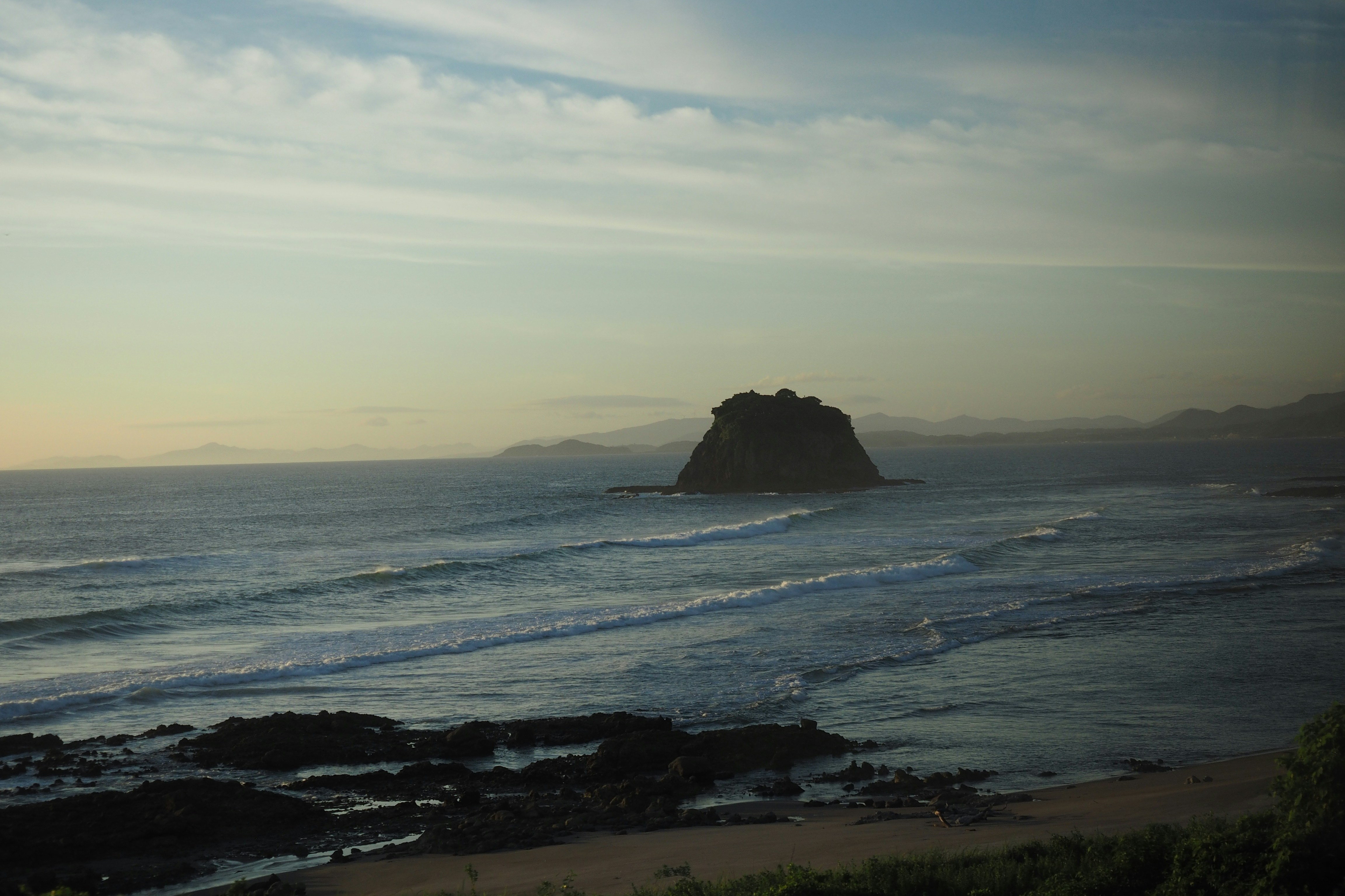 Isolated Sea Rock Amid Quiet Tides at Dusk