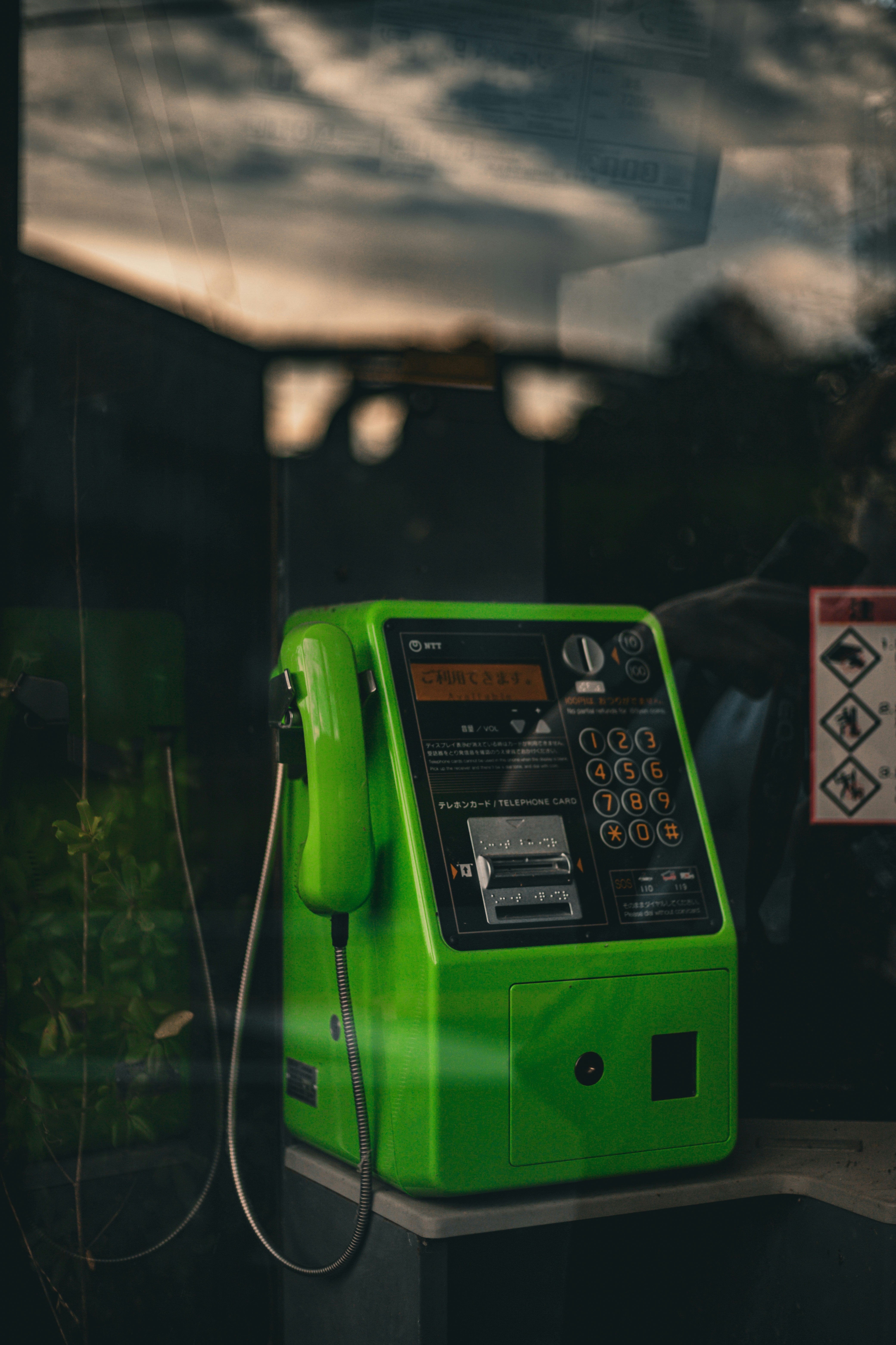 Emerald Terminal: Public Payphone in a Quiet Scene