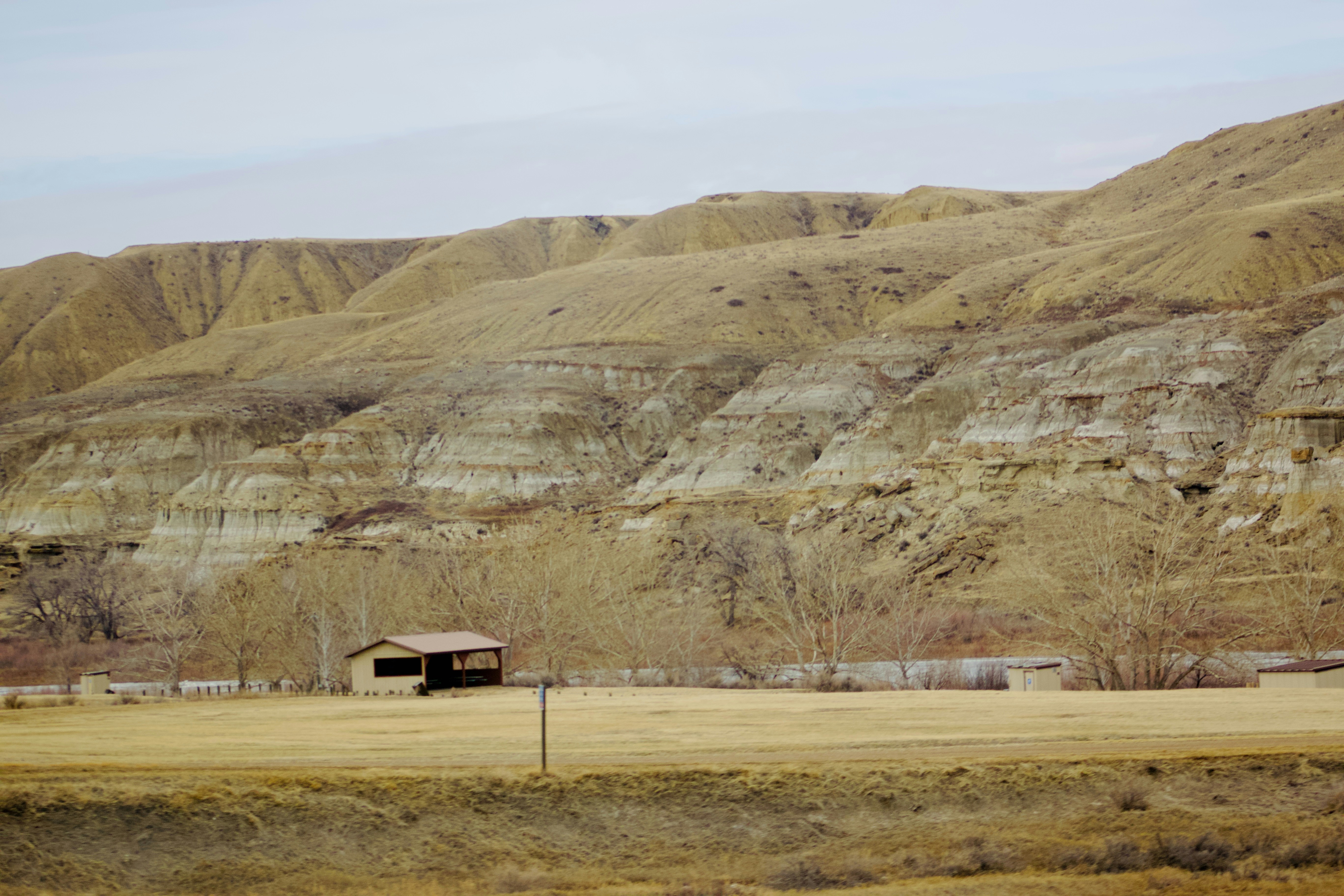 Lonely Barn At The Foot of Layered Hills