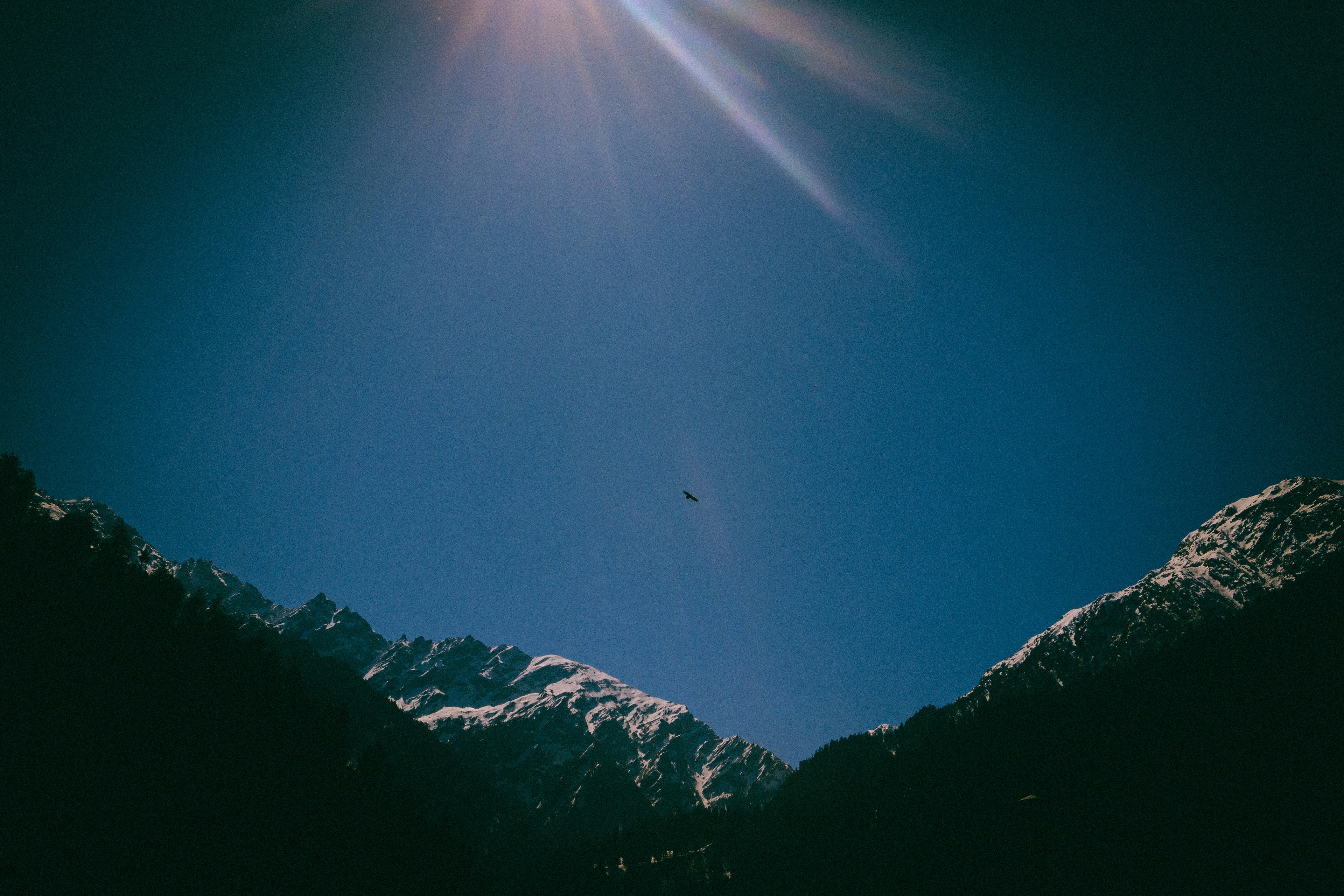 Sunburst over jagged ridge: a lone alpine silhouette