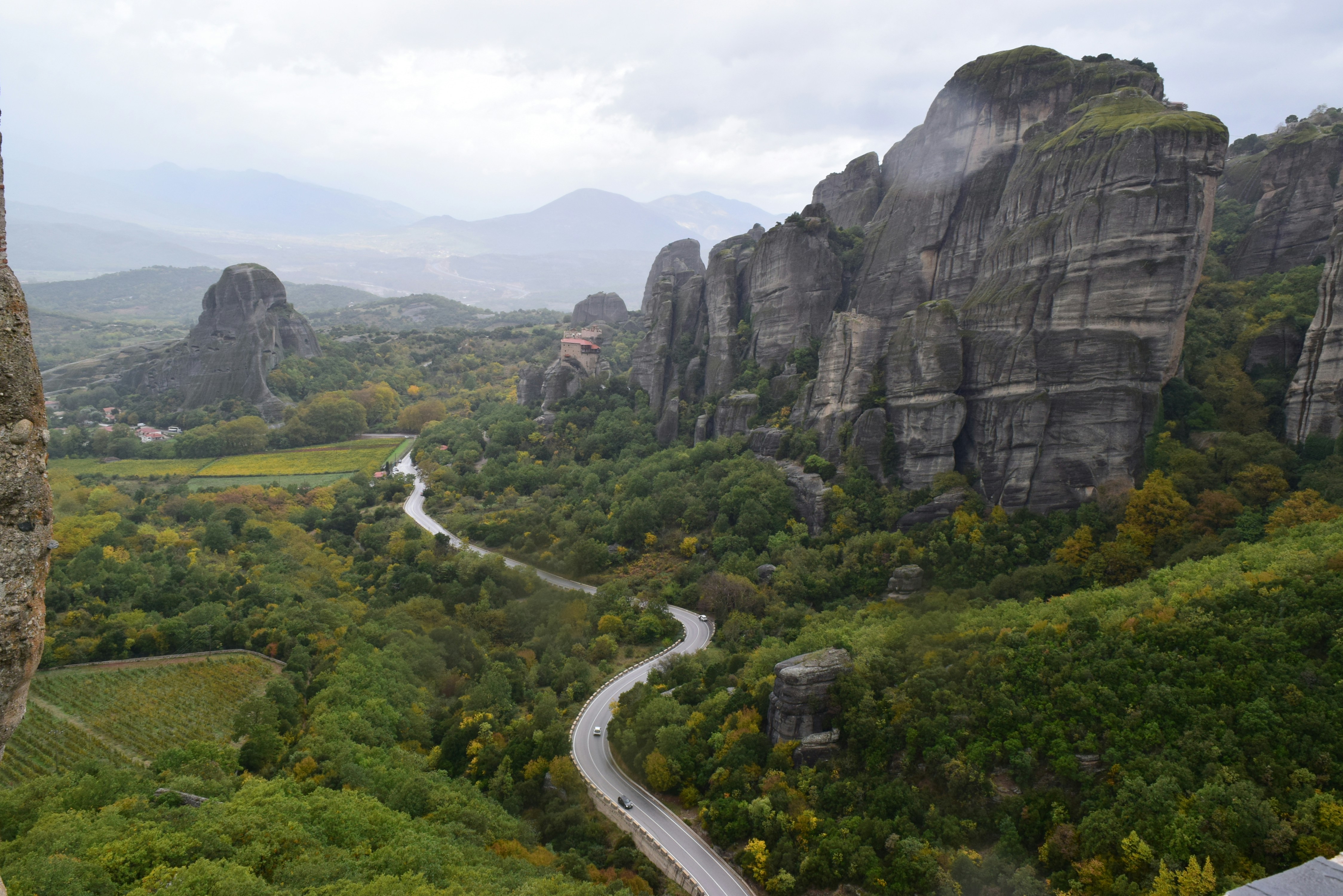 Venture Between Giants: River Road Winding Through Monolithic Spires