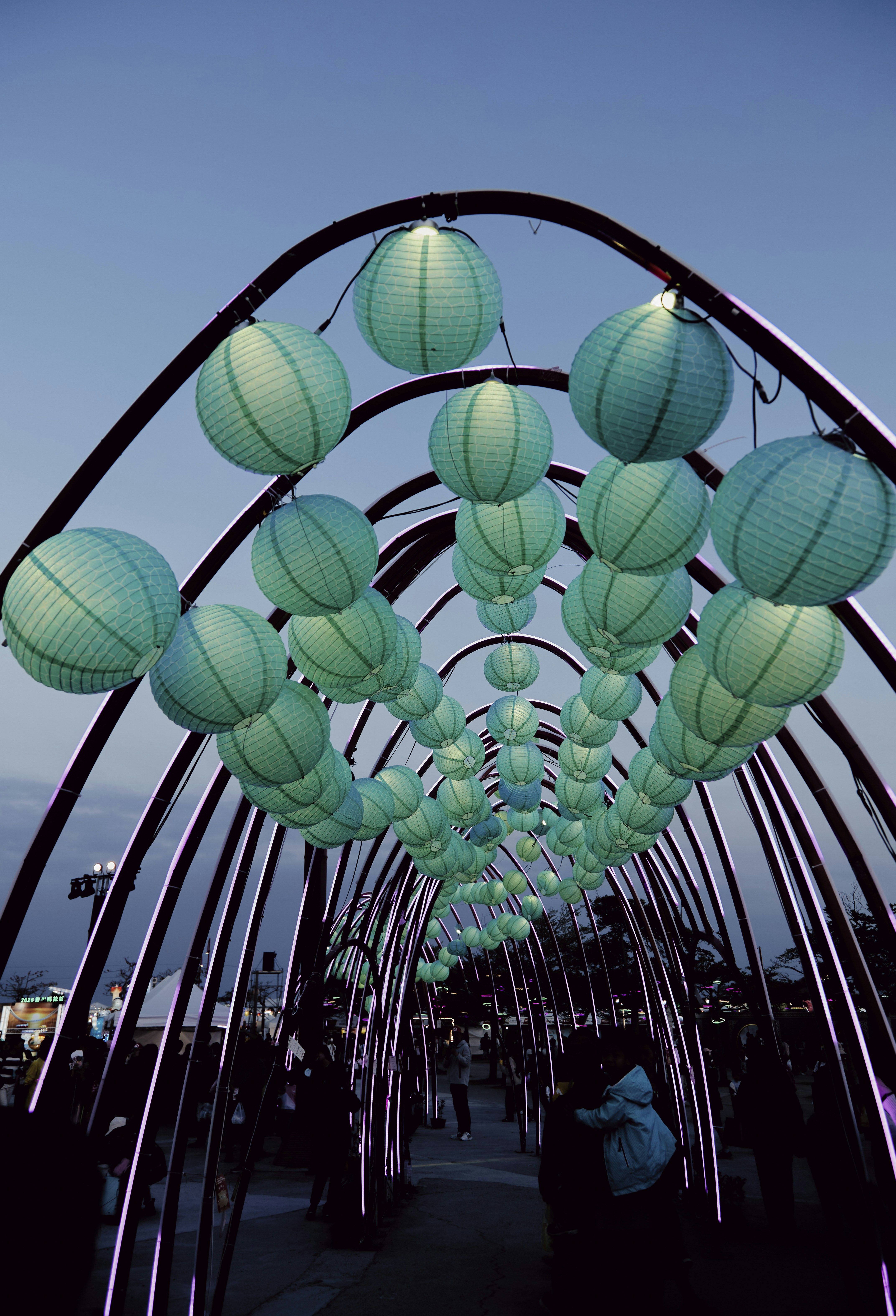 Lanterns in Transit: Neon Arches Exploring a Twilight Corridor