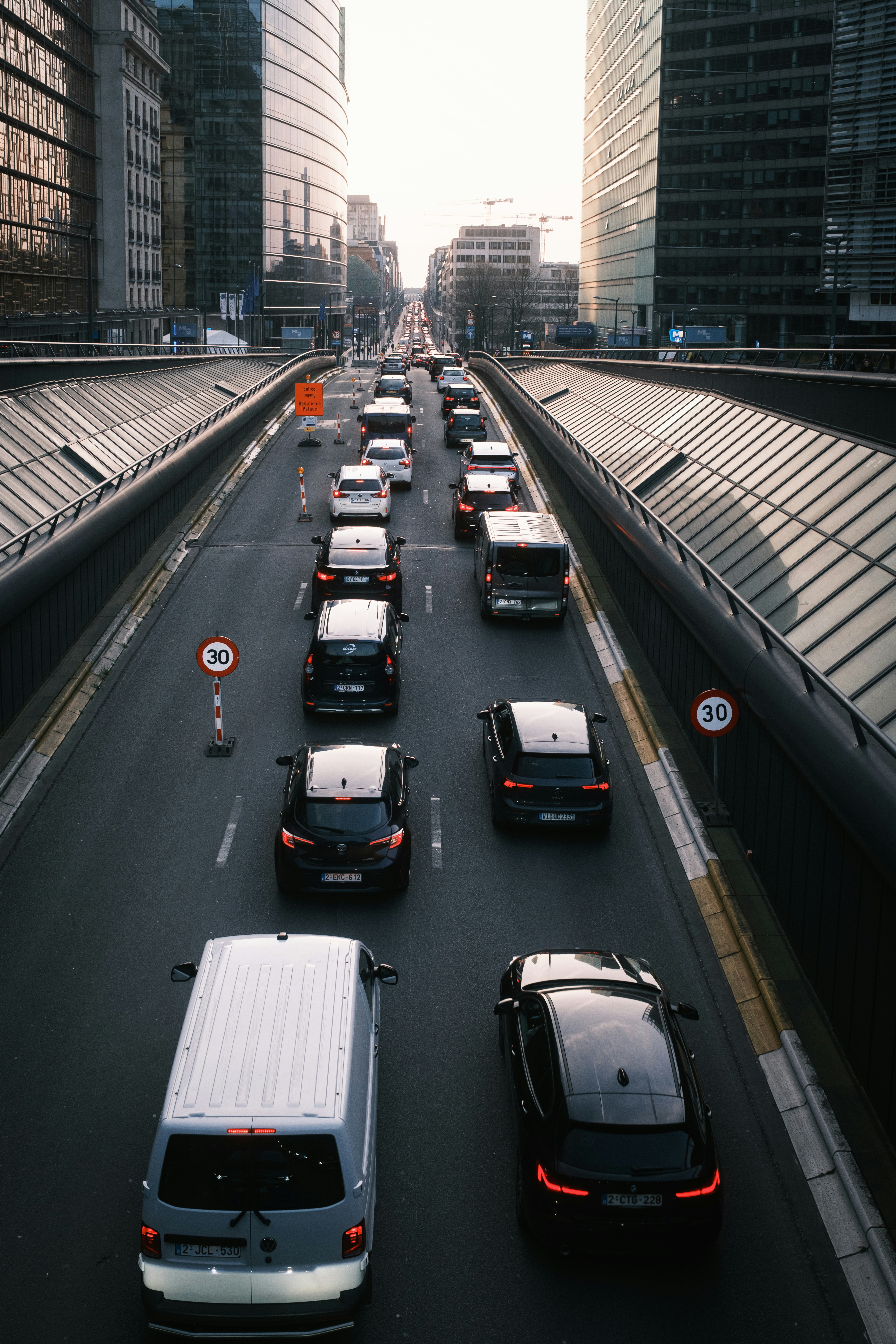 Urban Artery: Cars Stream Through a Sunlit City Corridor