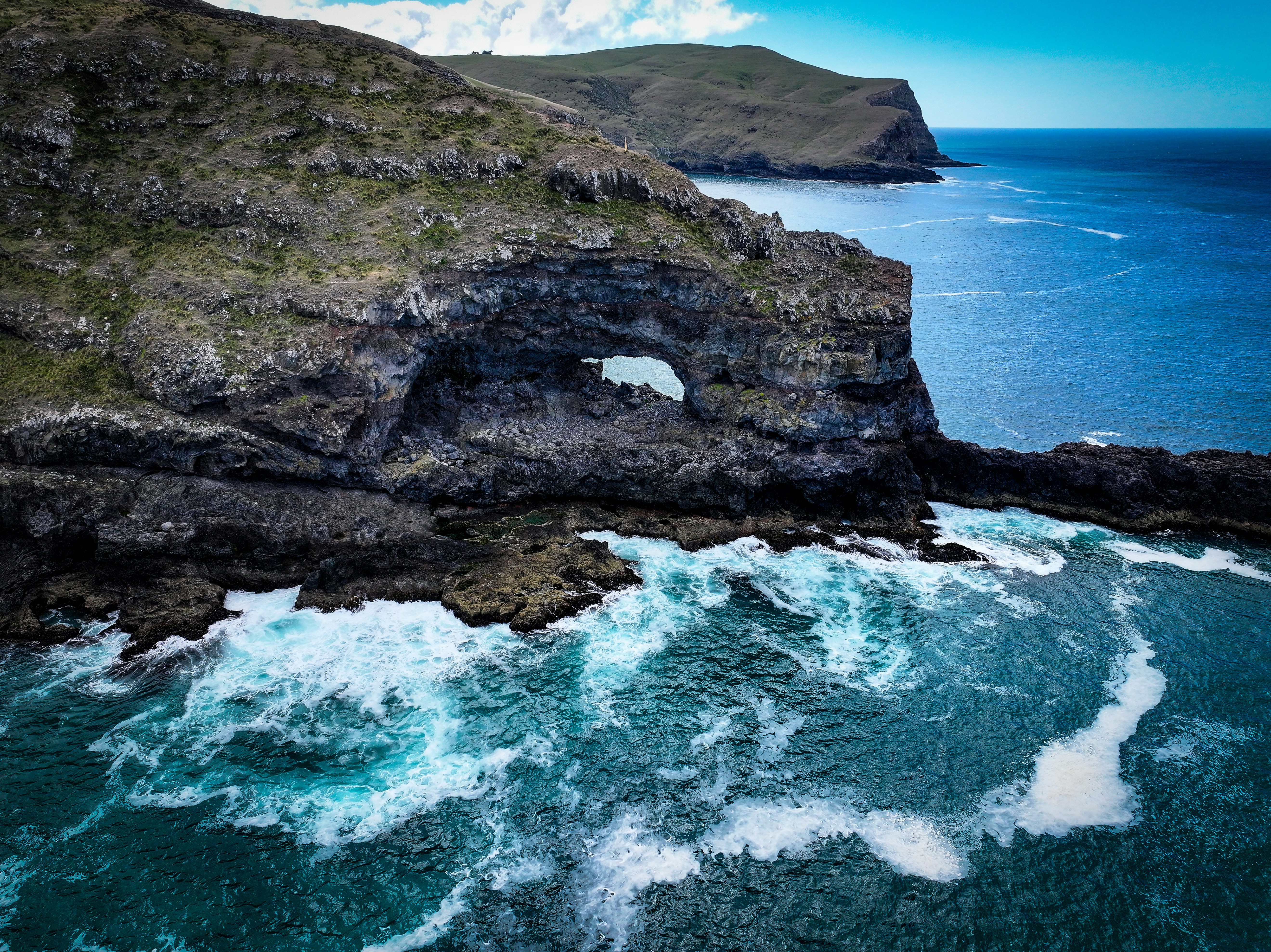 Sea Arch Over Turquoise Waves: Cliffside Coastline