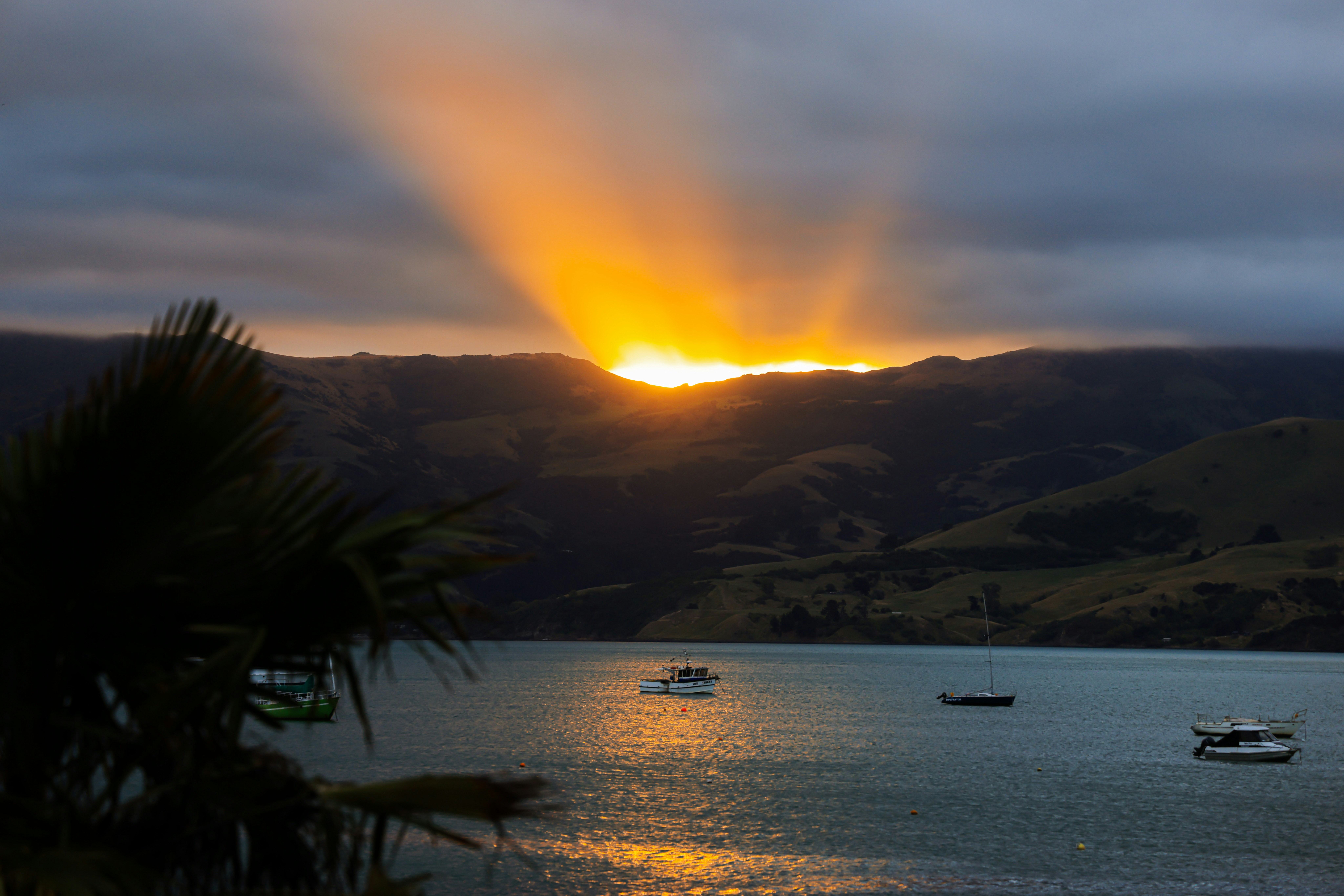 Sunbreak Over the Bay: Boats at Dusk