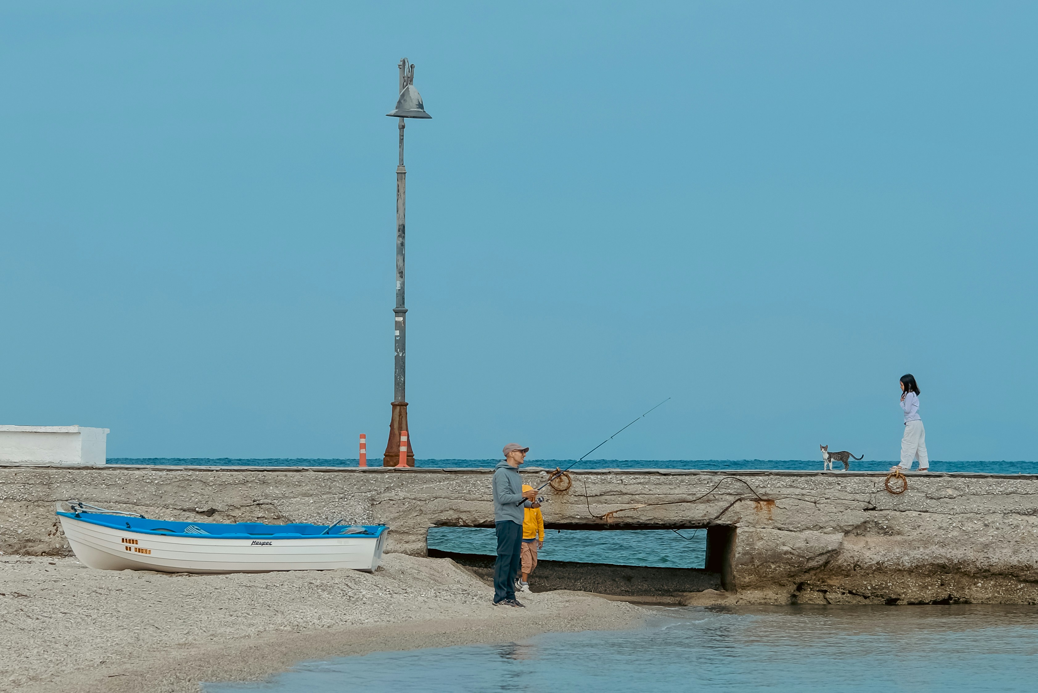 Quiet Harbor Moment: A Lone Figure Shapes the Shoreline