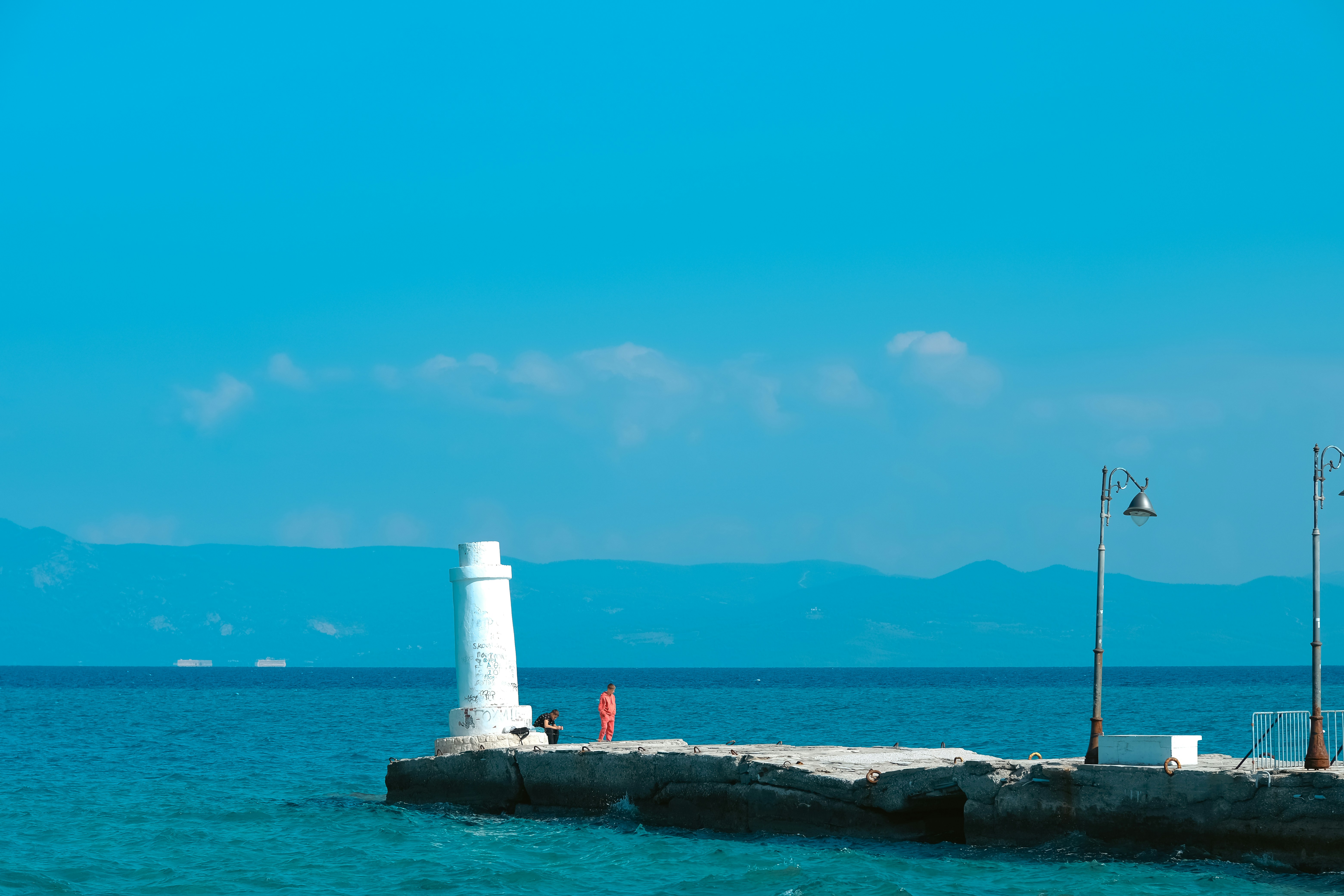 Lone Lighthouse Sentinel at the End of a Quiet Pier