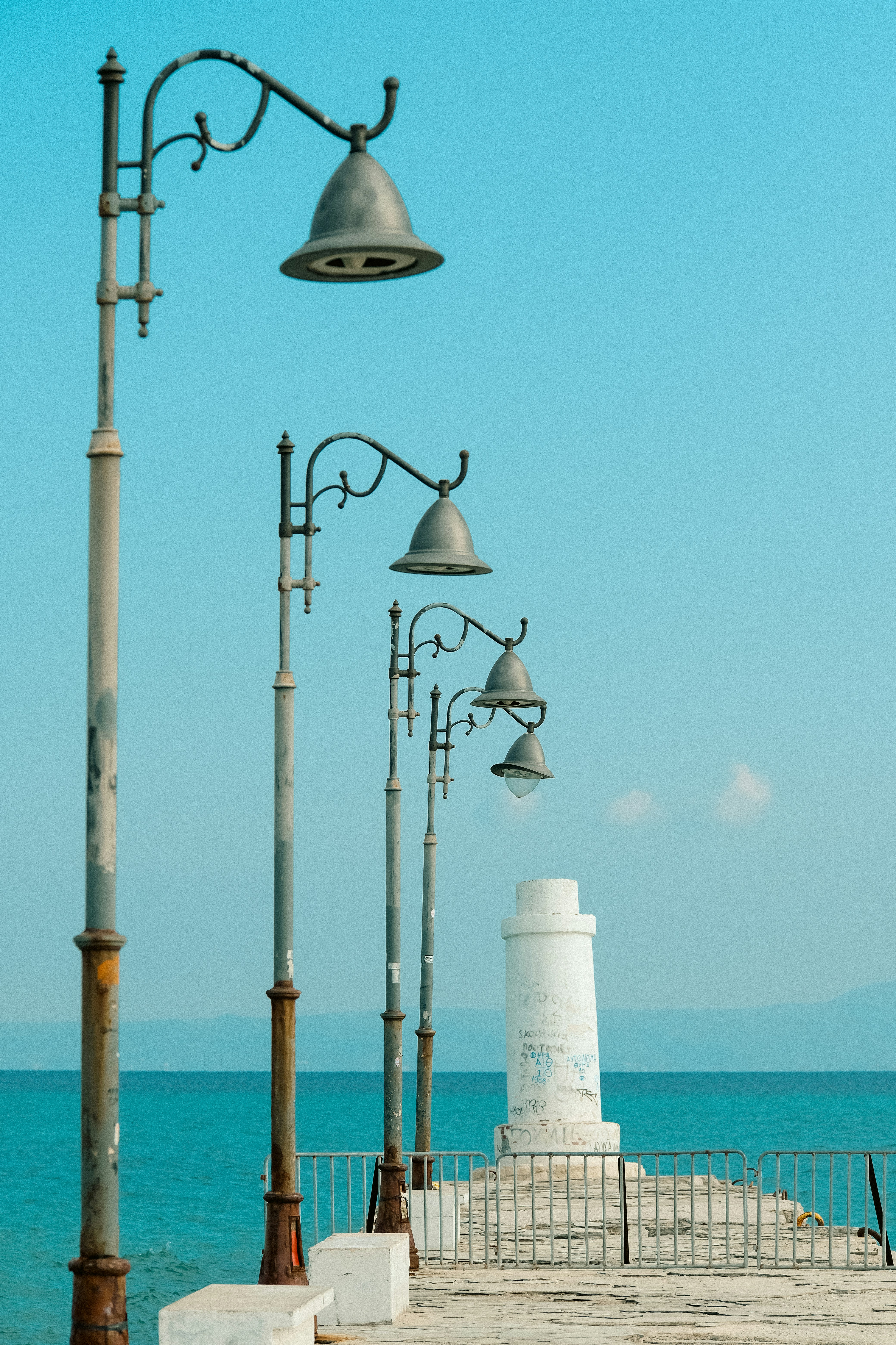 Row of Vintage Pier Lamps Leading to a Sea Breeze