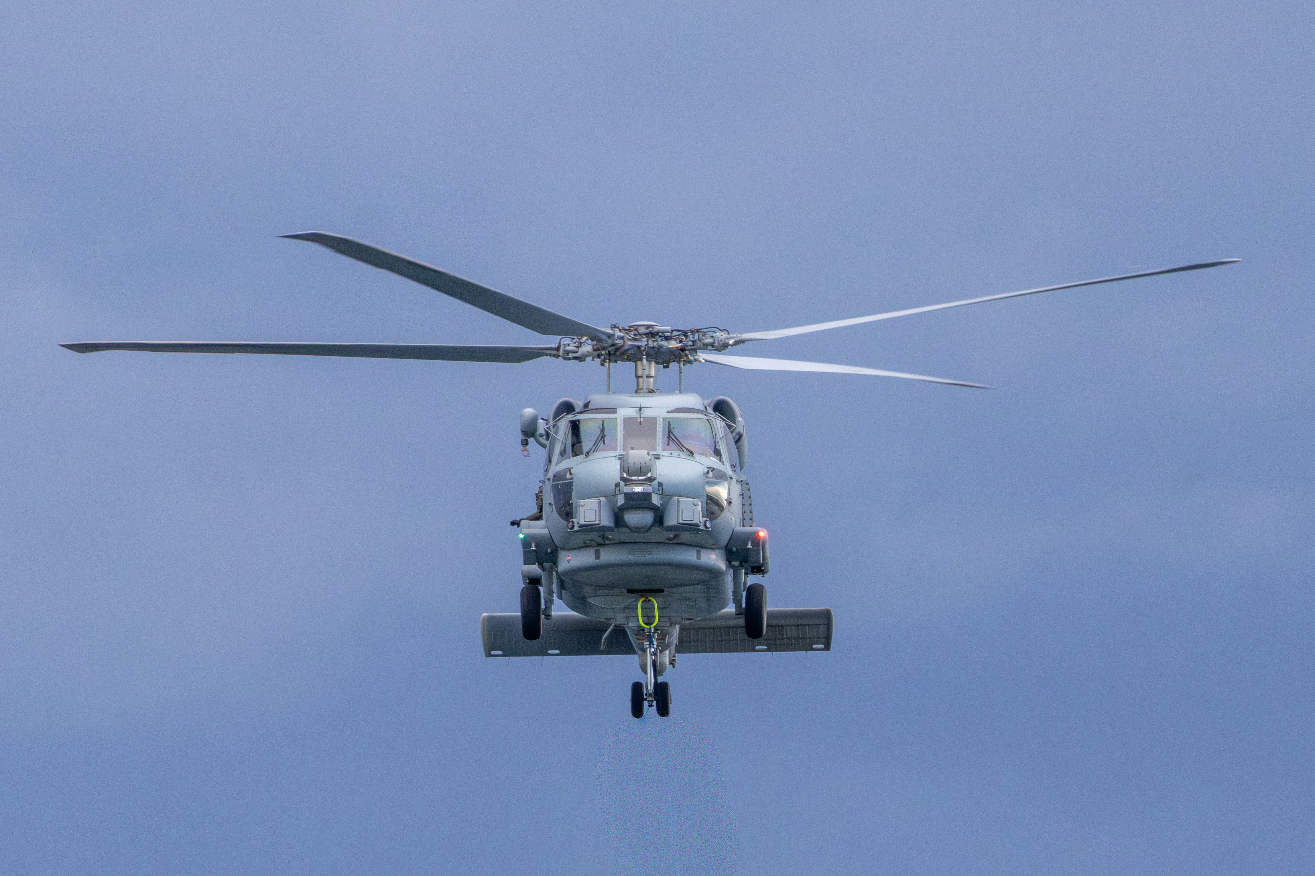 Front-Facing Royal Hue: A Helicopter in Focus Against A Quiet Sky