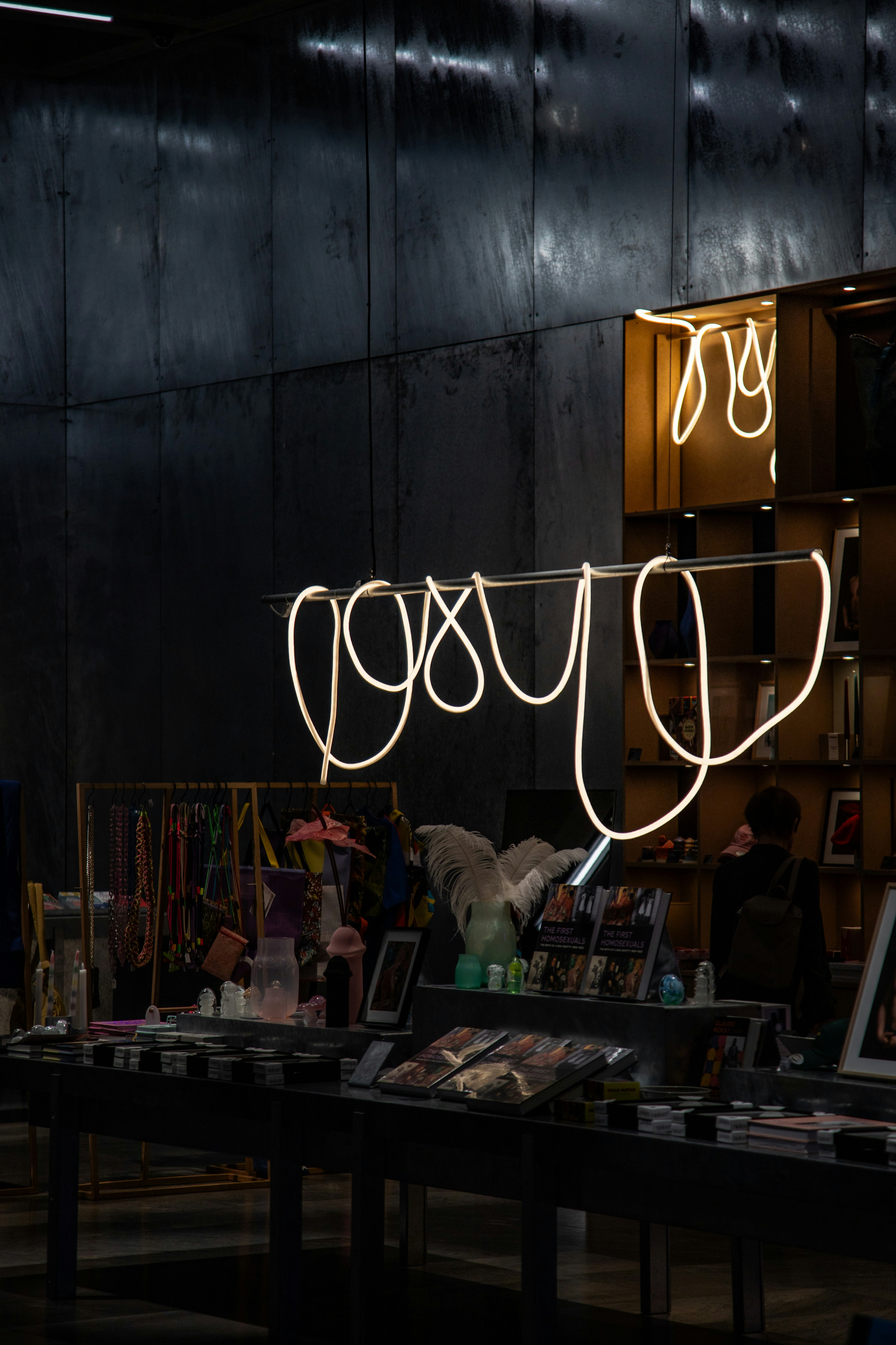 Neon Looping Illuminations in a Dark Bookstore Studio