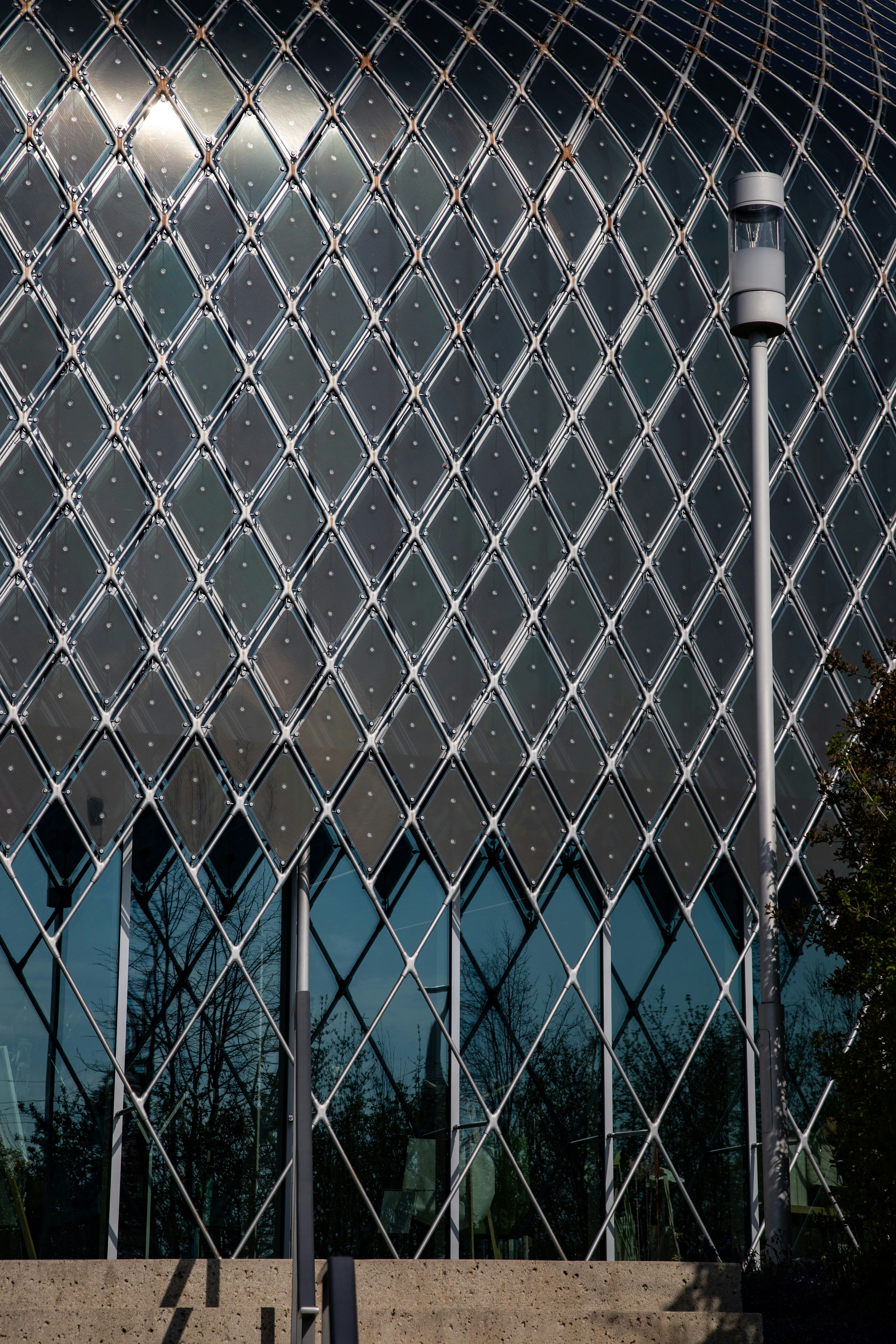 Diamond-patterned Facade: Sunlit Glass and Shadow