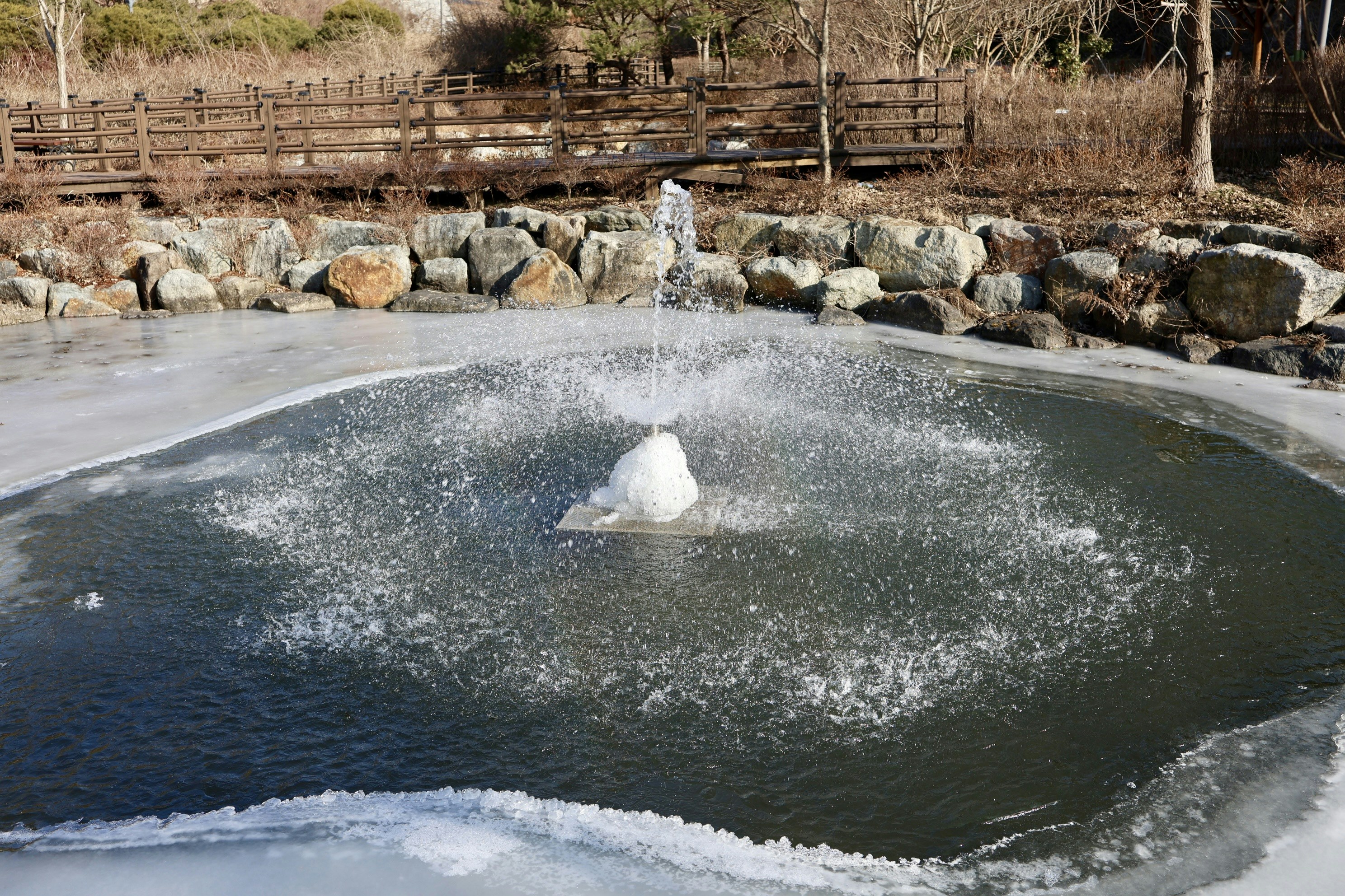 Frozen Fountain at Dusk: A Quiet Sliver of Water Surrounded by Winter Stone