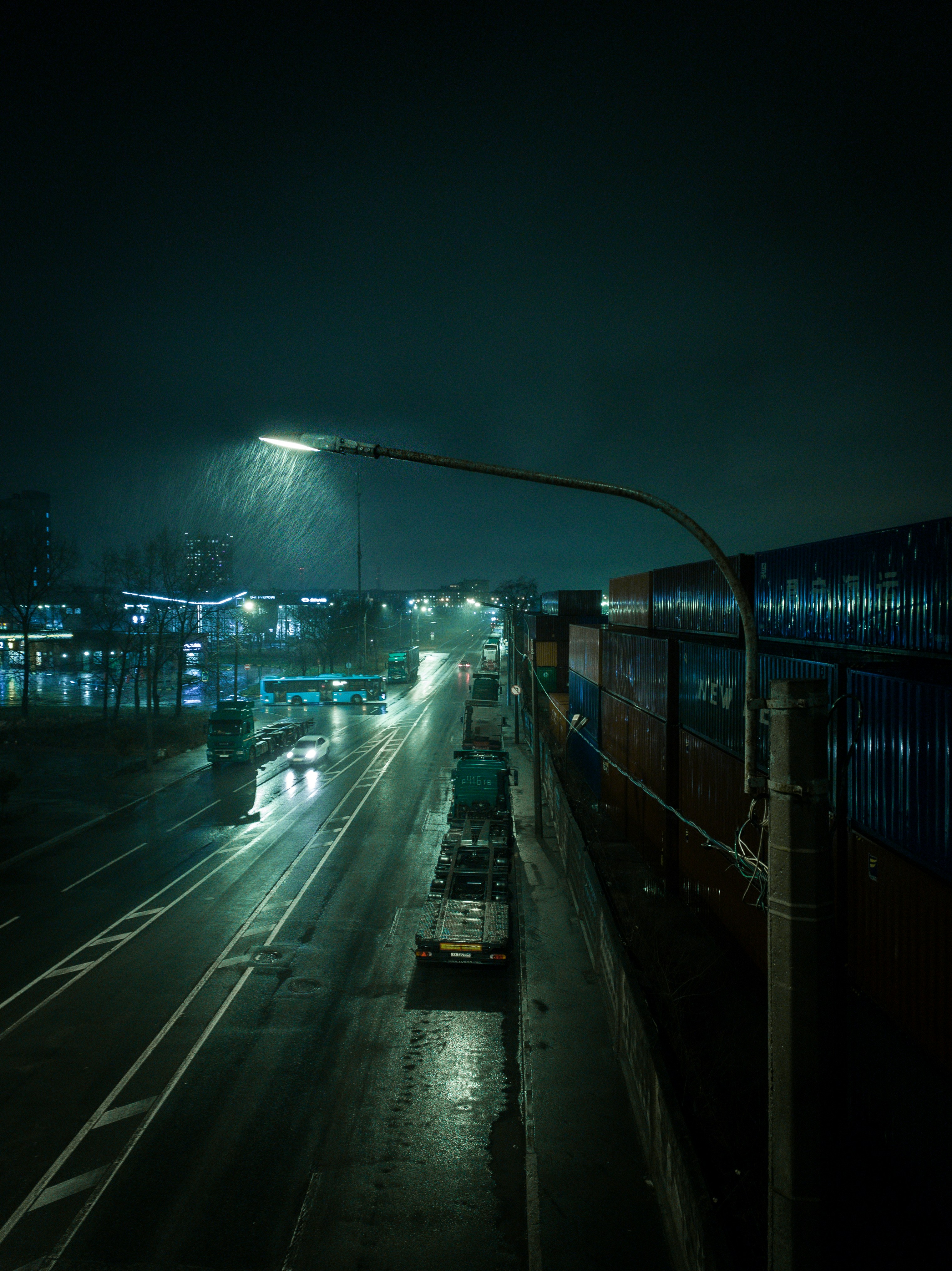 Midnight Run: Rain-Slicked Street Under the Catenary of Light