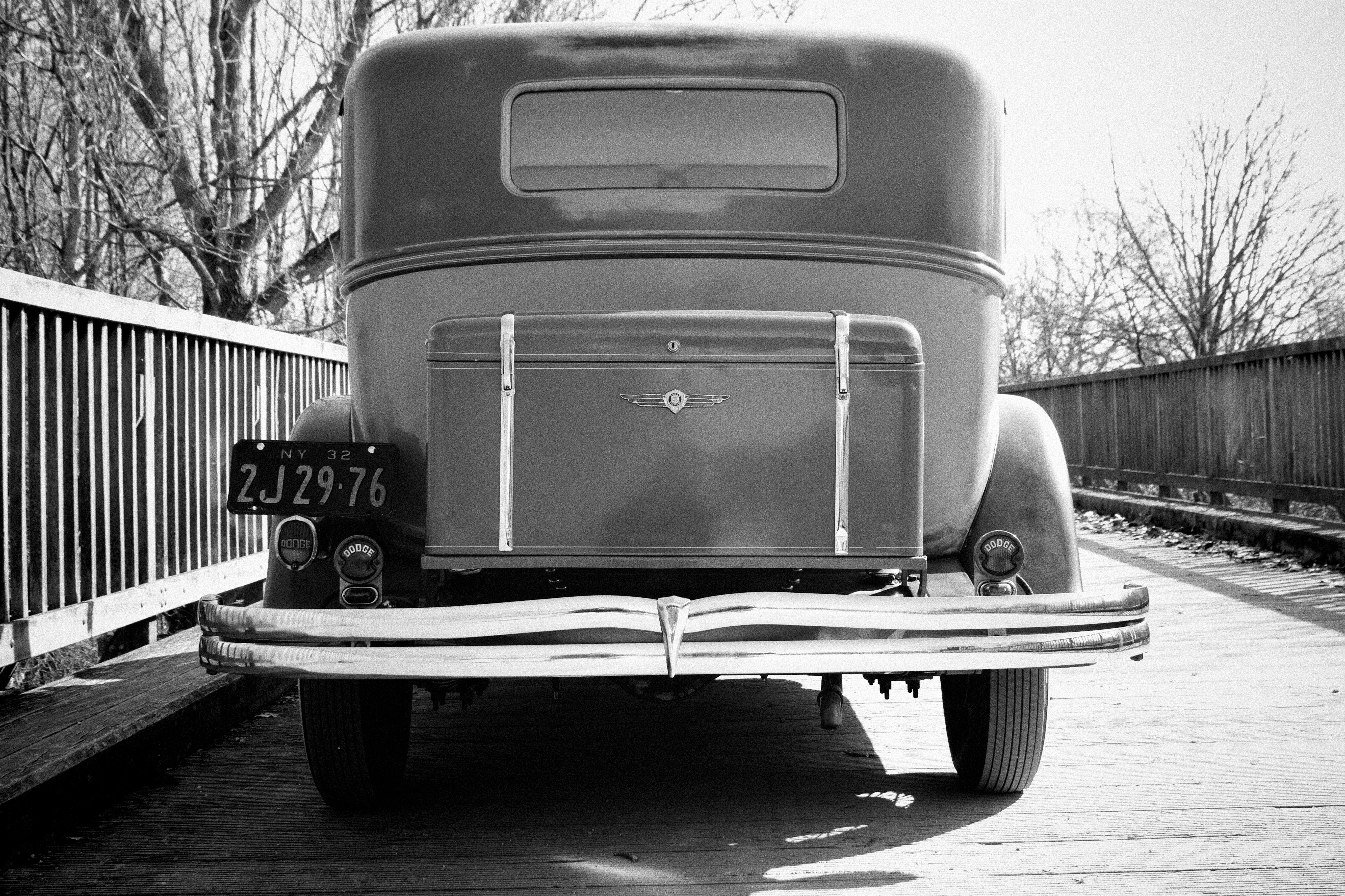 Rear View of a Vintage Sedan: Quiet Roadway Echoes of Past Journeys