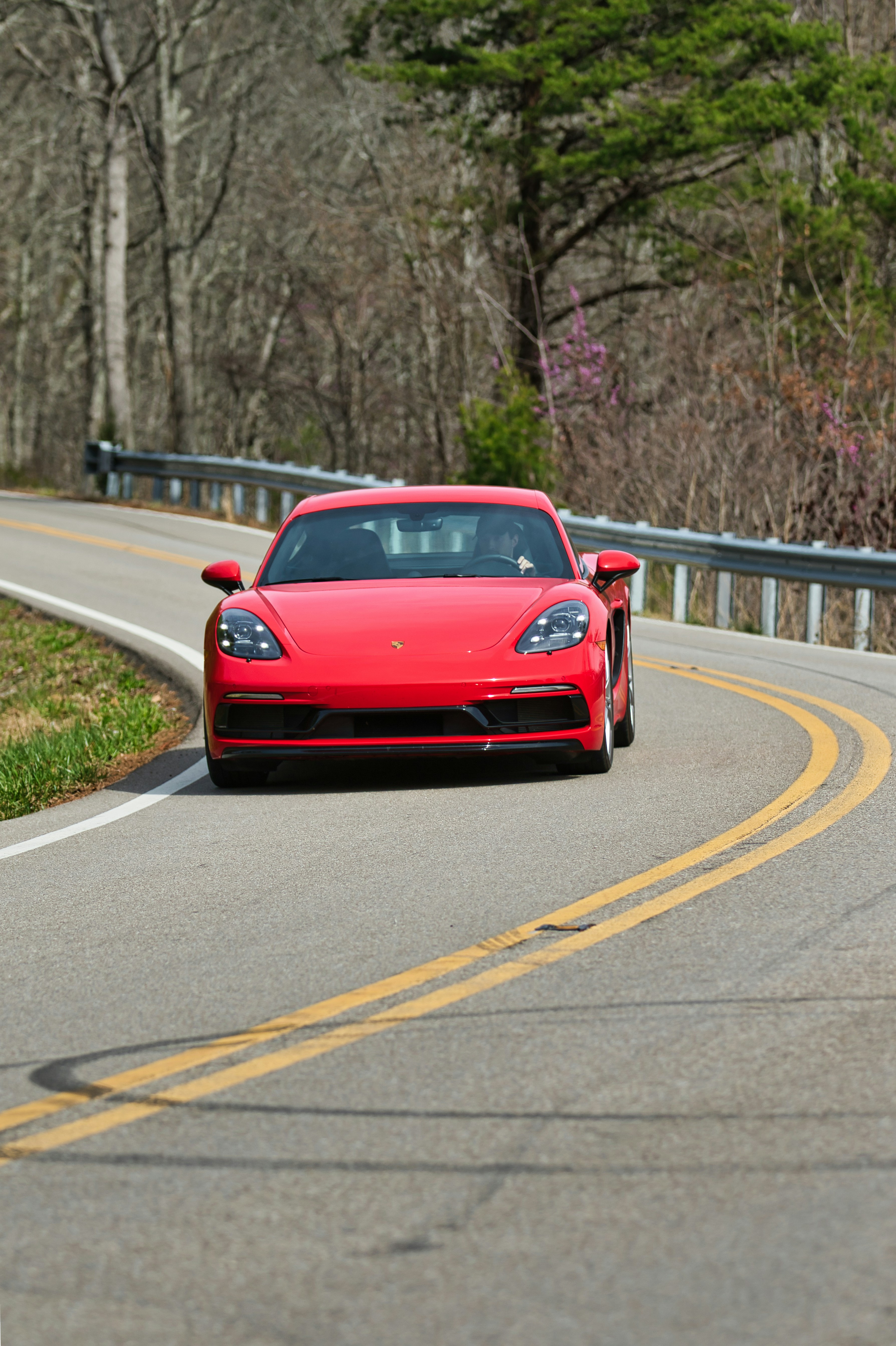 Red Porsche Leads the Wind-Touched Road