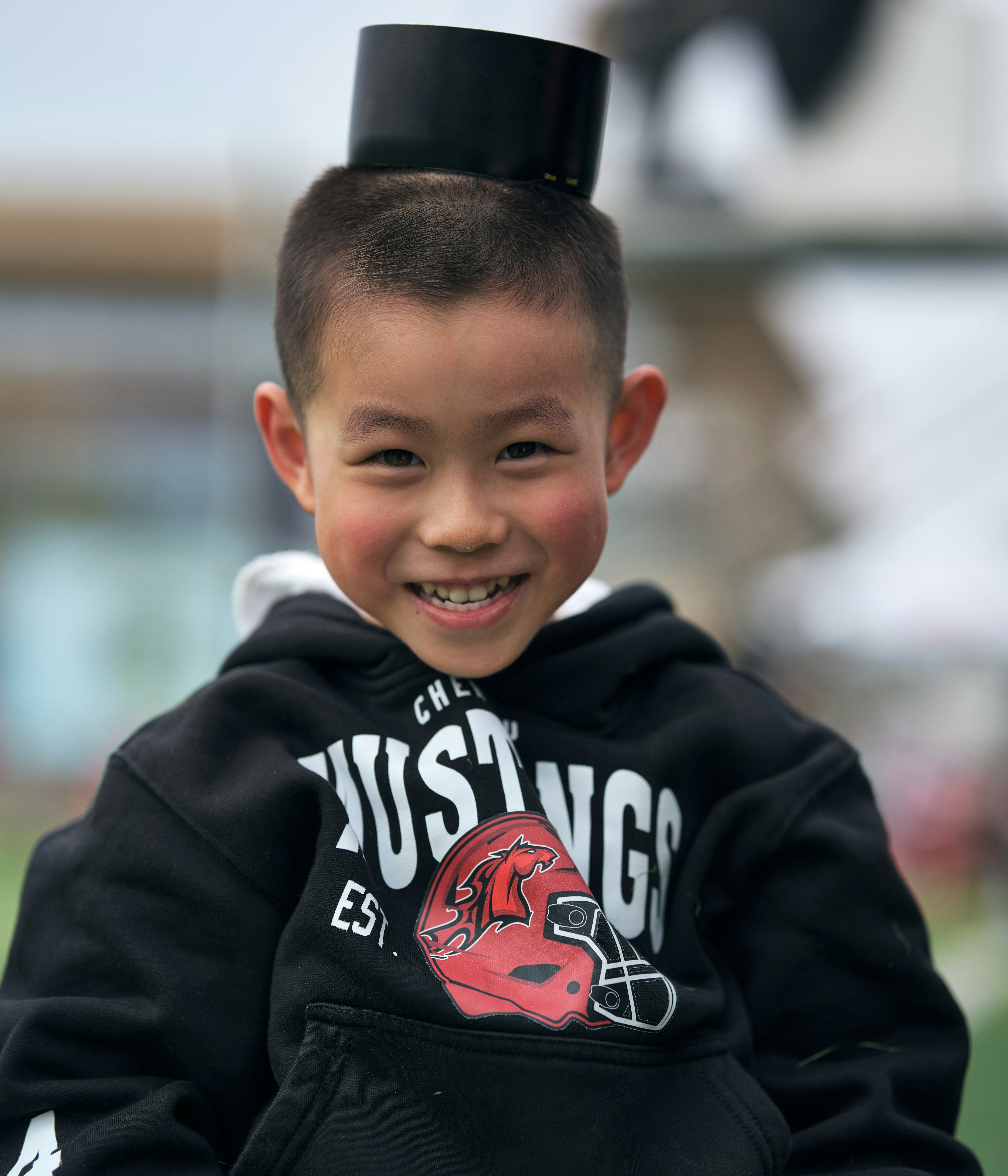 Smiling Moment Under a Tiny Crown: Playful Portrait with Hoodie Detail
