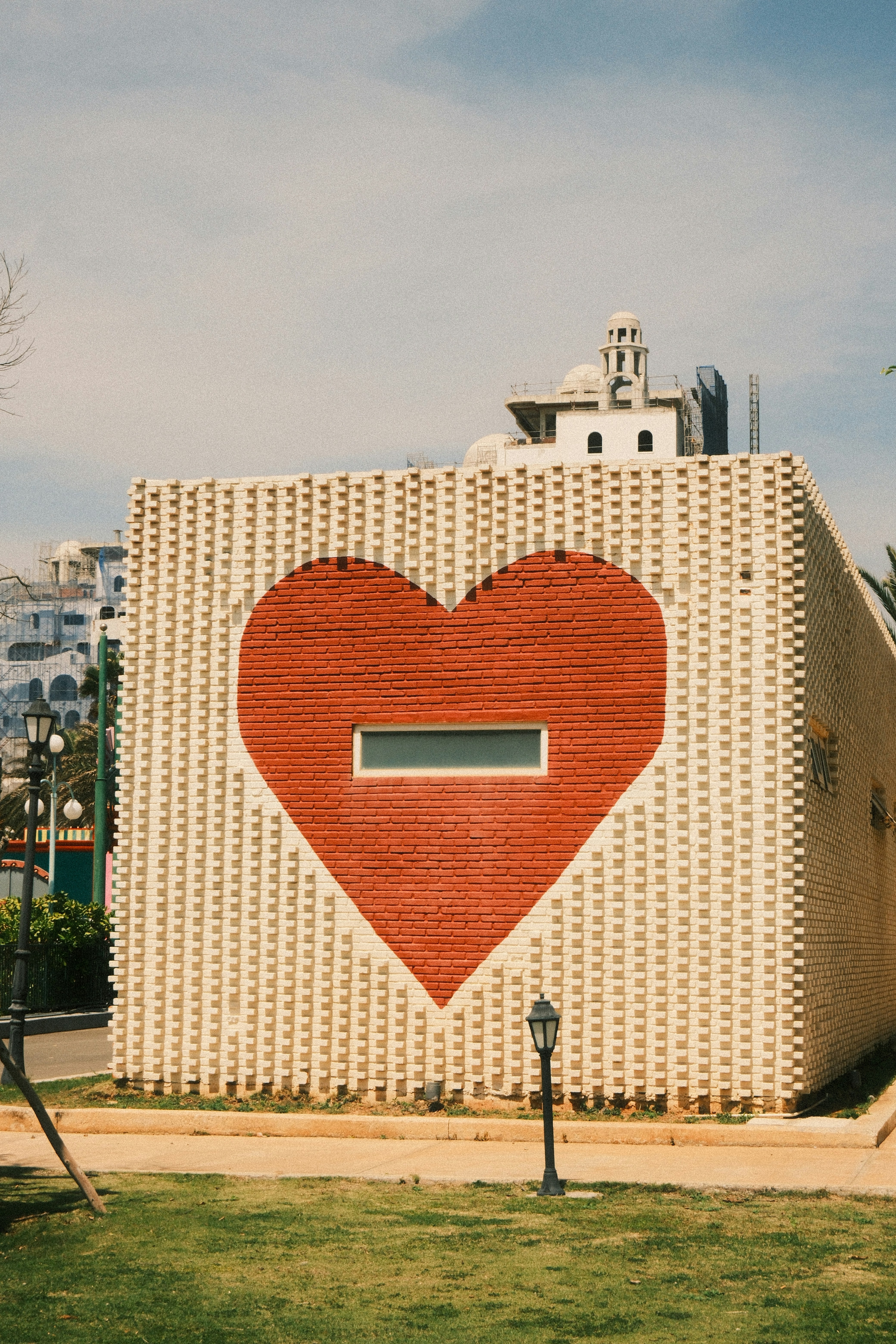 Heart on the Wall: A Red Emblem in a Brick Facade