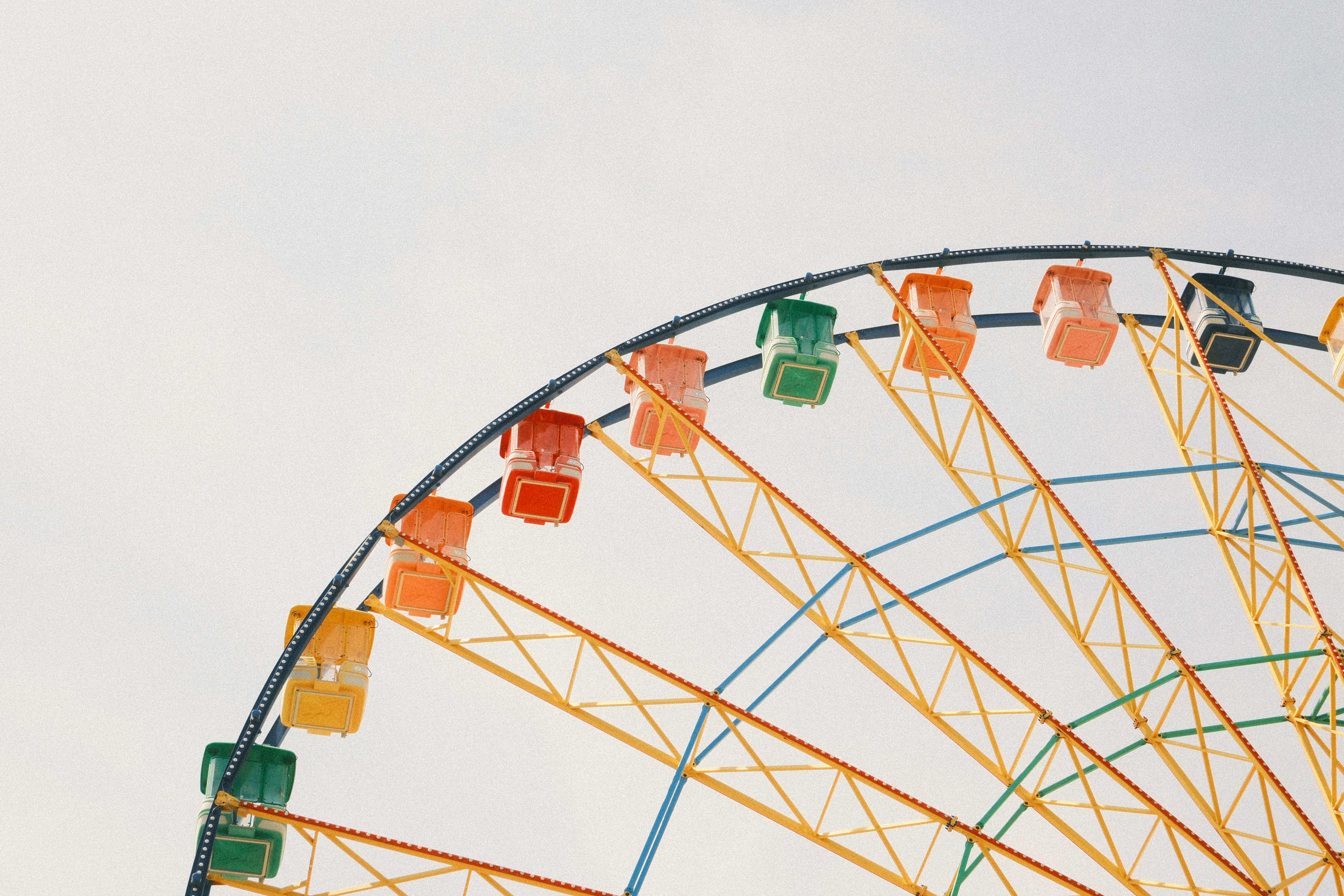 Colorful Ferris Wheel Arc Against a Quiet Sky