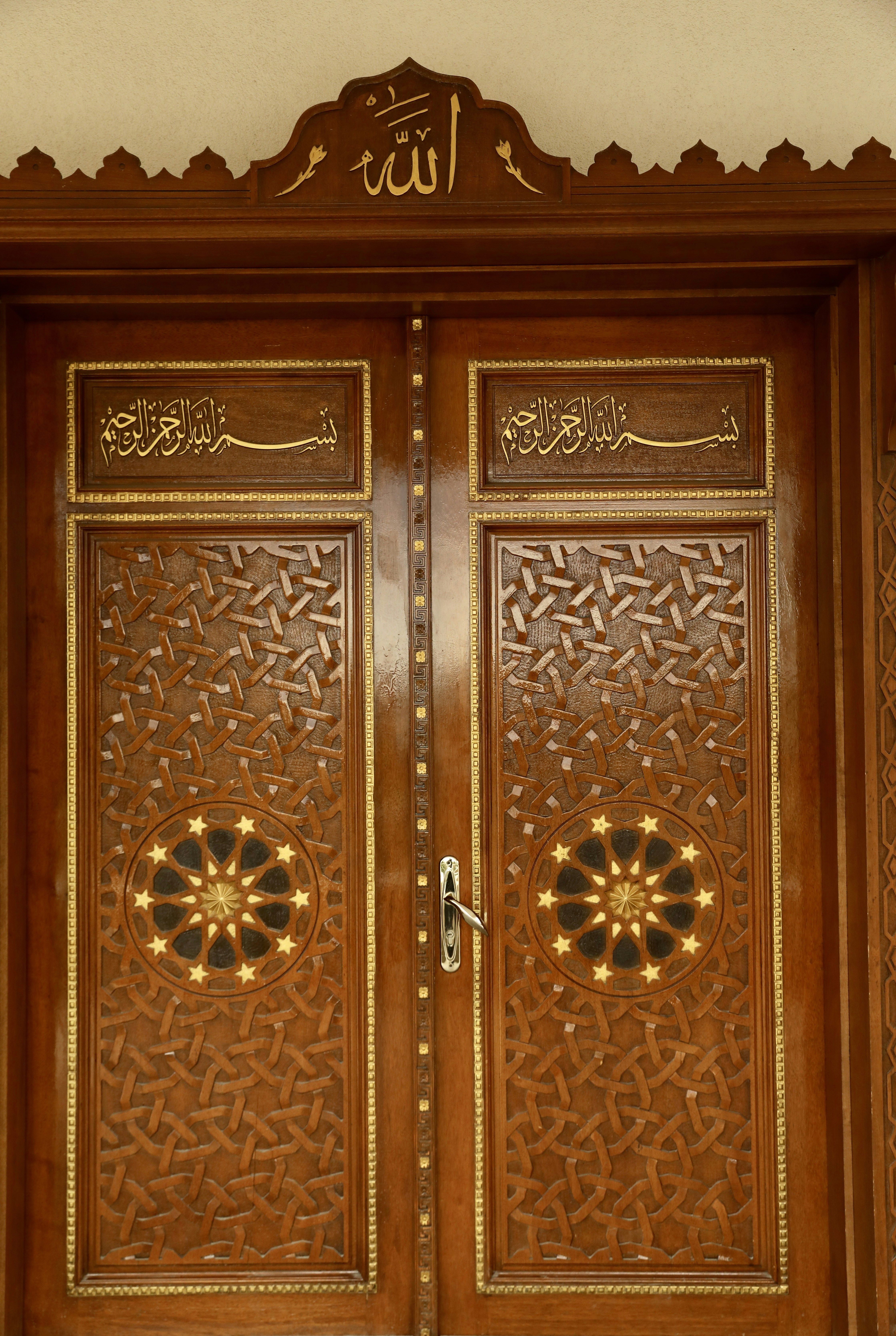 Ornate Islamic Doorway: Lattice Panels and Calligraphic Top