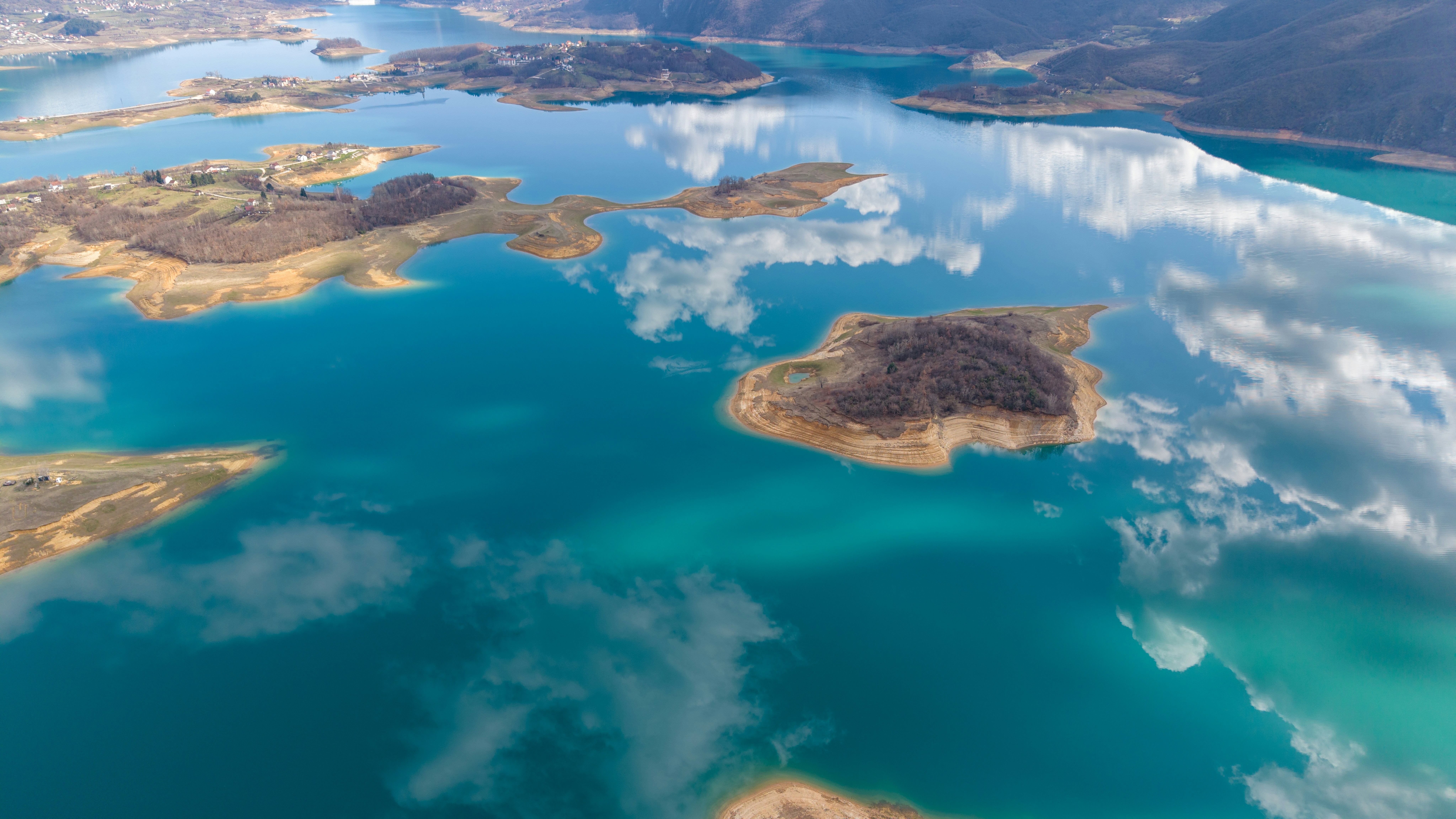 Azure Islands and Mirror Sky: Aerial Dance Over Turquoise Lagoons