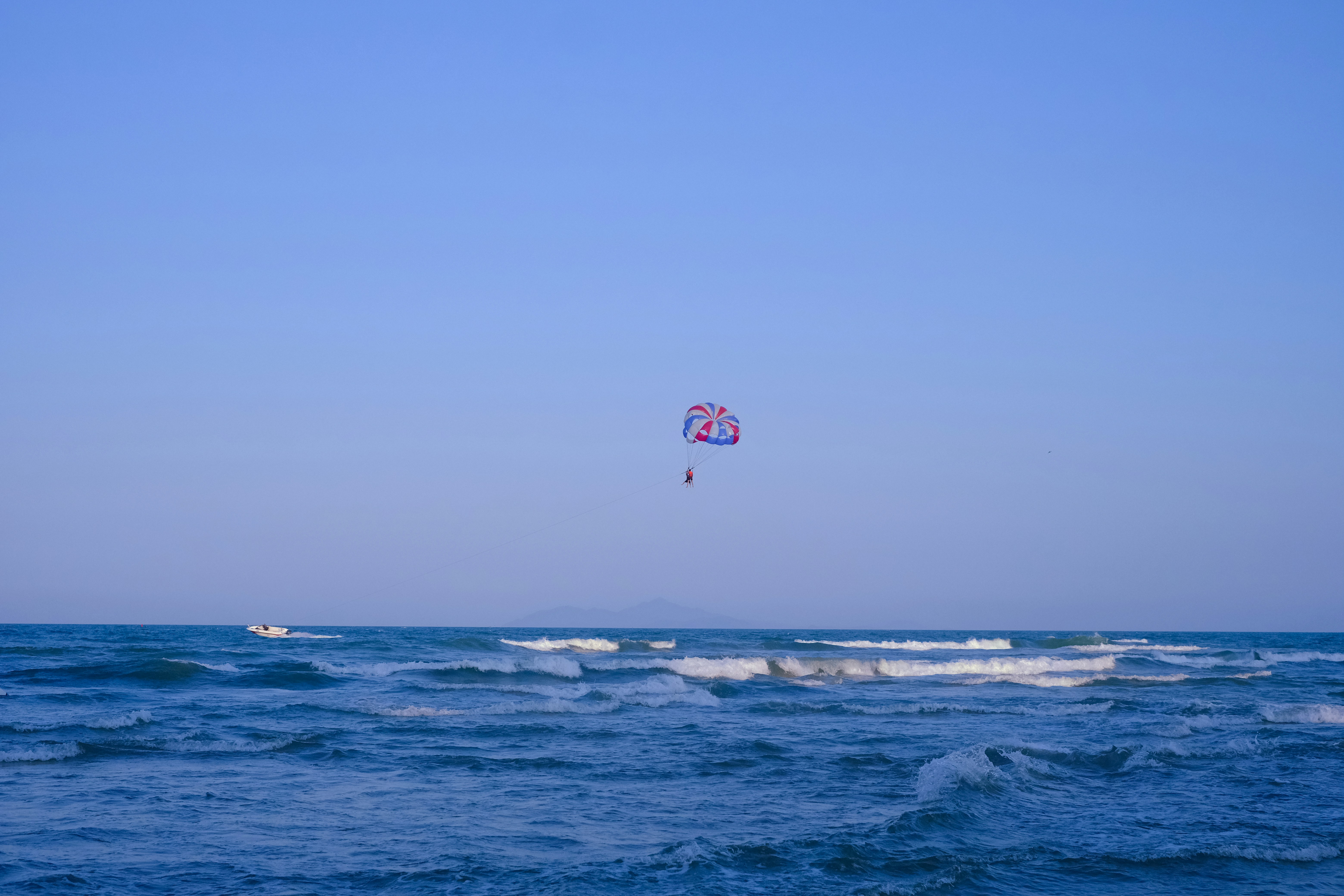 Floating Dawn: Kite Surfer Above Quiet Atlantic Waves
