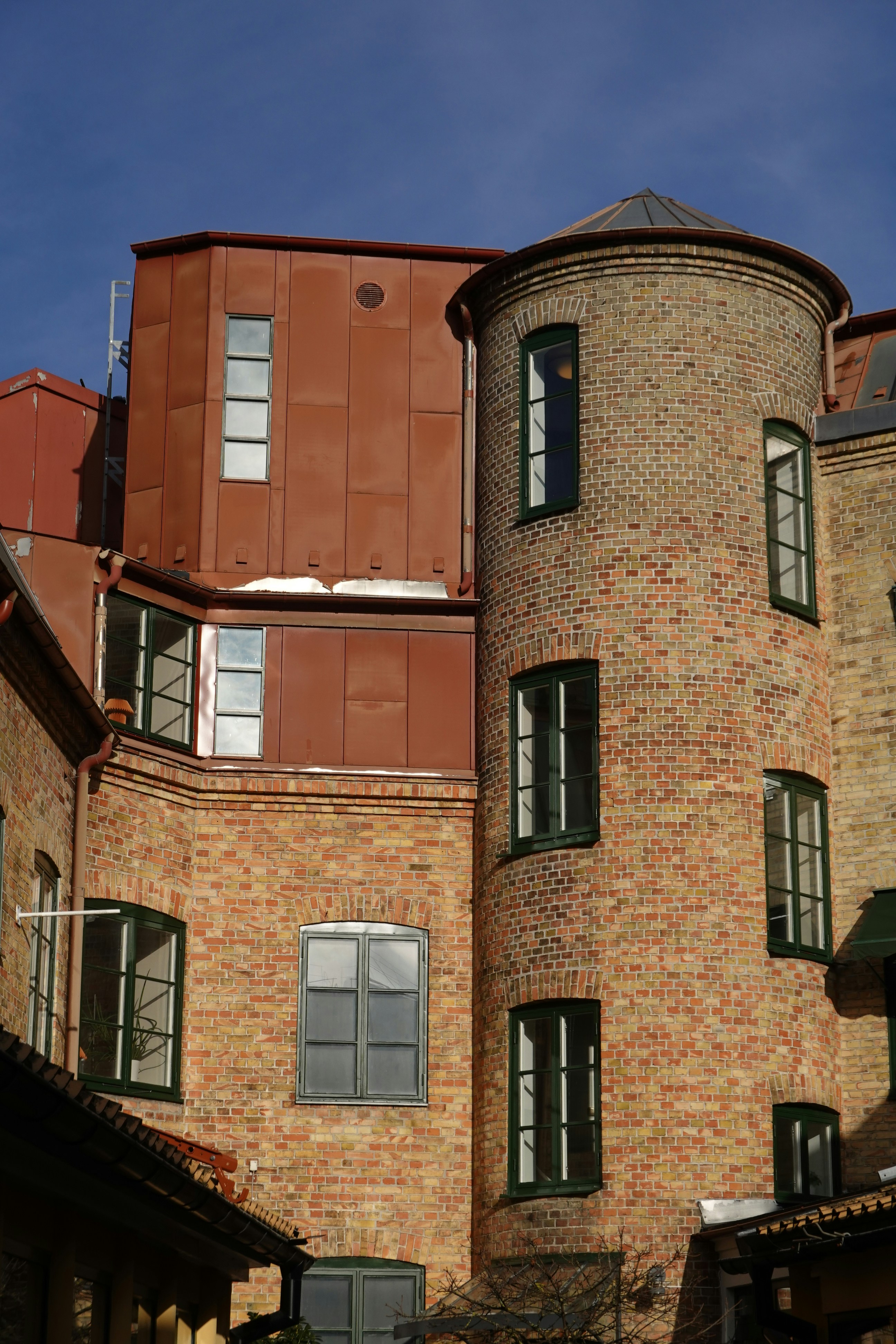 Brick Turreted Facade with Varied Roofing: A Corner of an Urban Courtyard