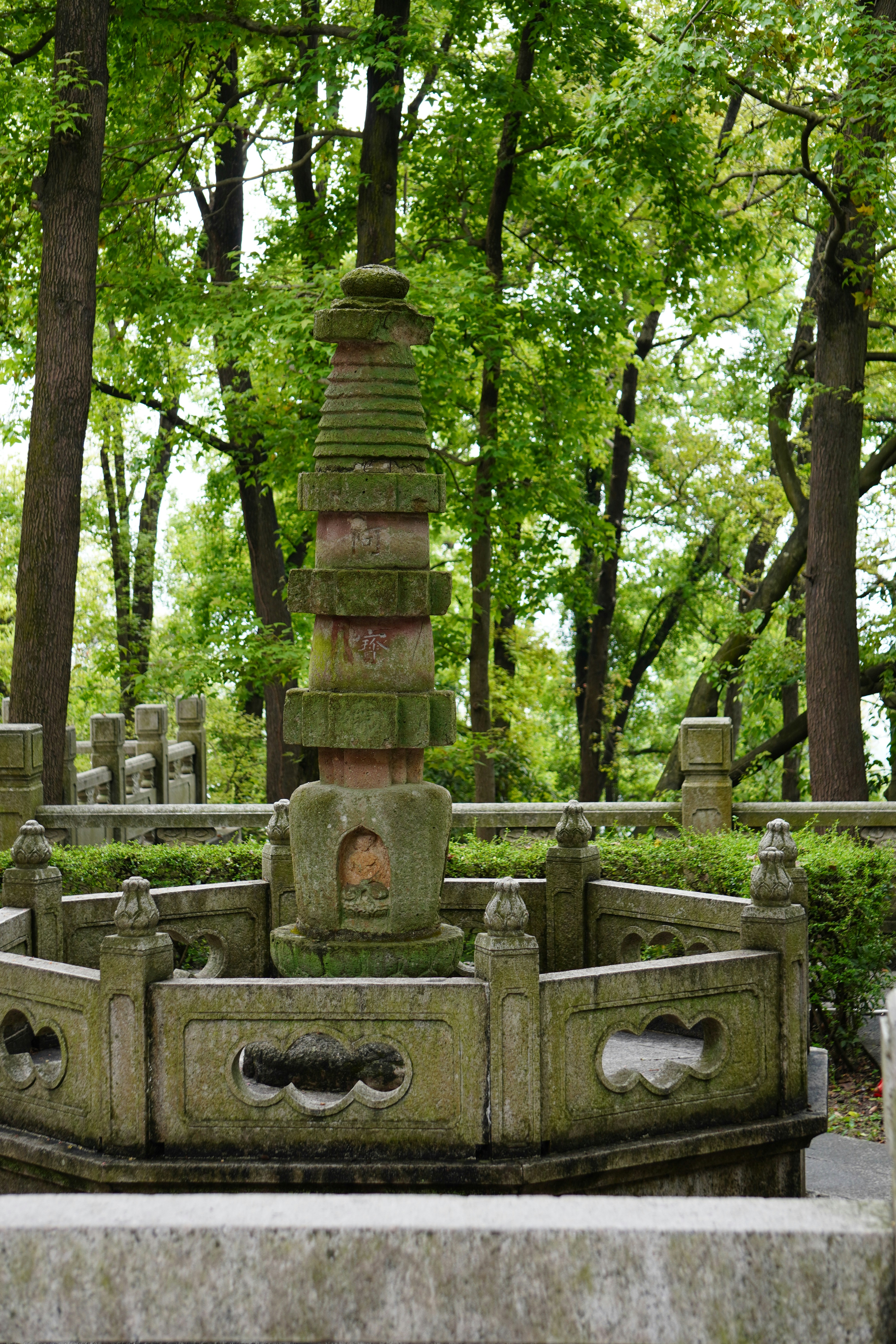 Ancient Stone Pagoda Guarded by Moss and Trees