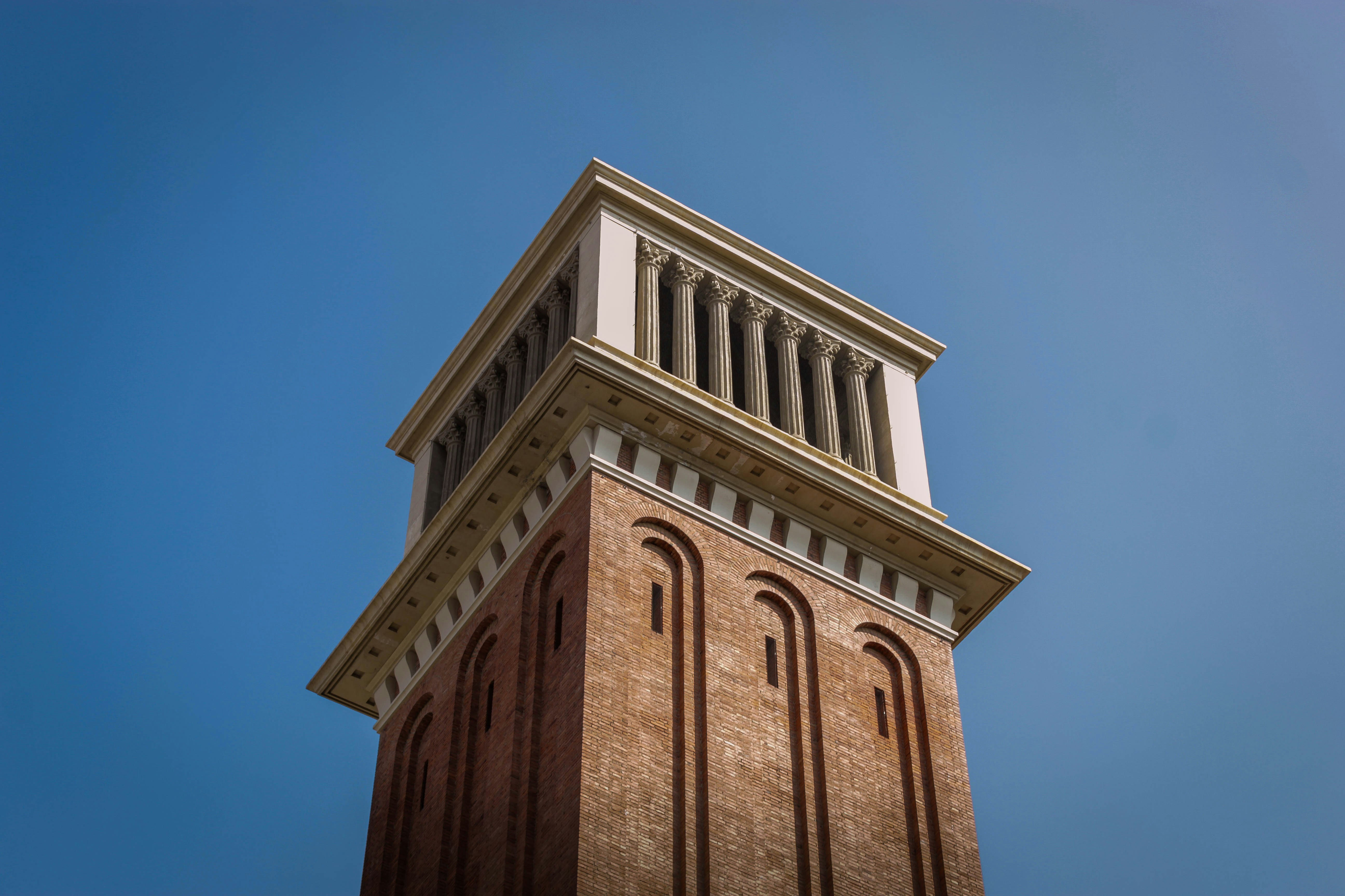 Brick Clocktower Reaching Toward a Clear Sky