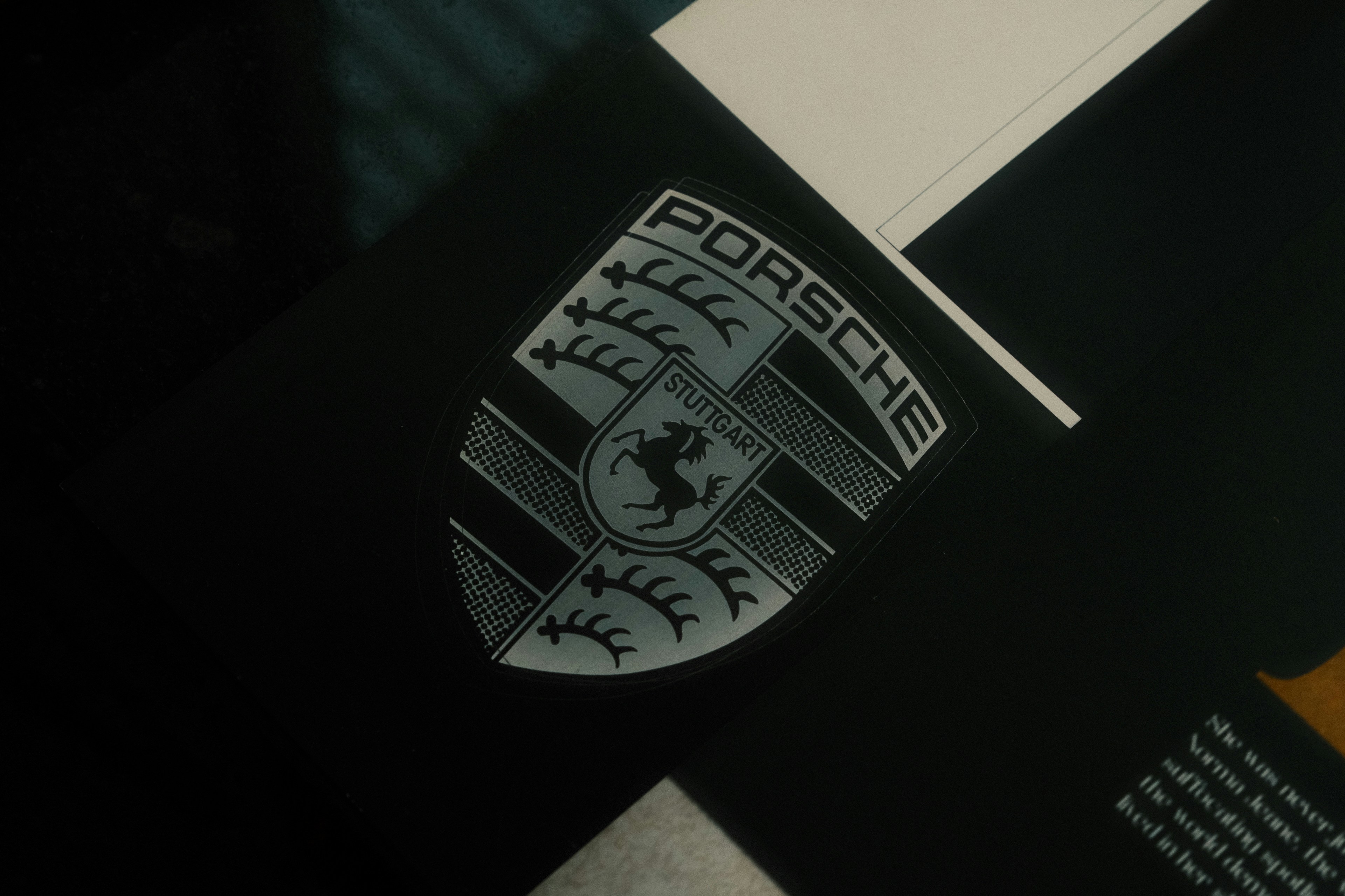 Emblem on dark panel: Porsche shield as focal cue