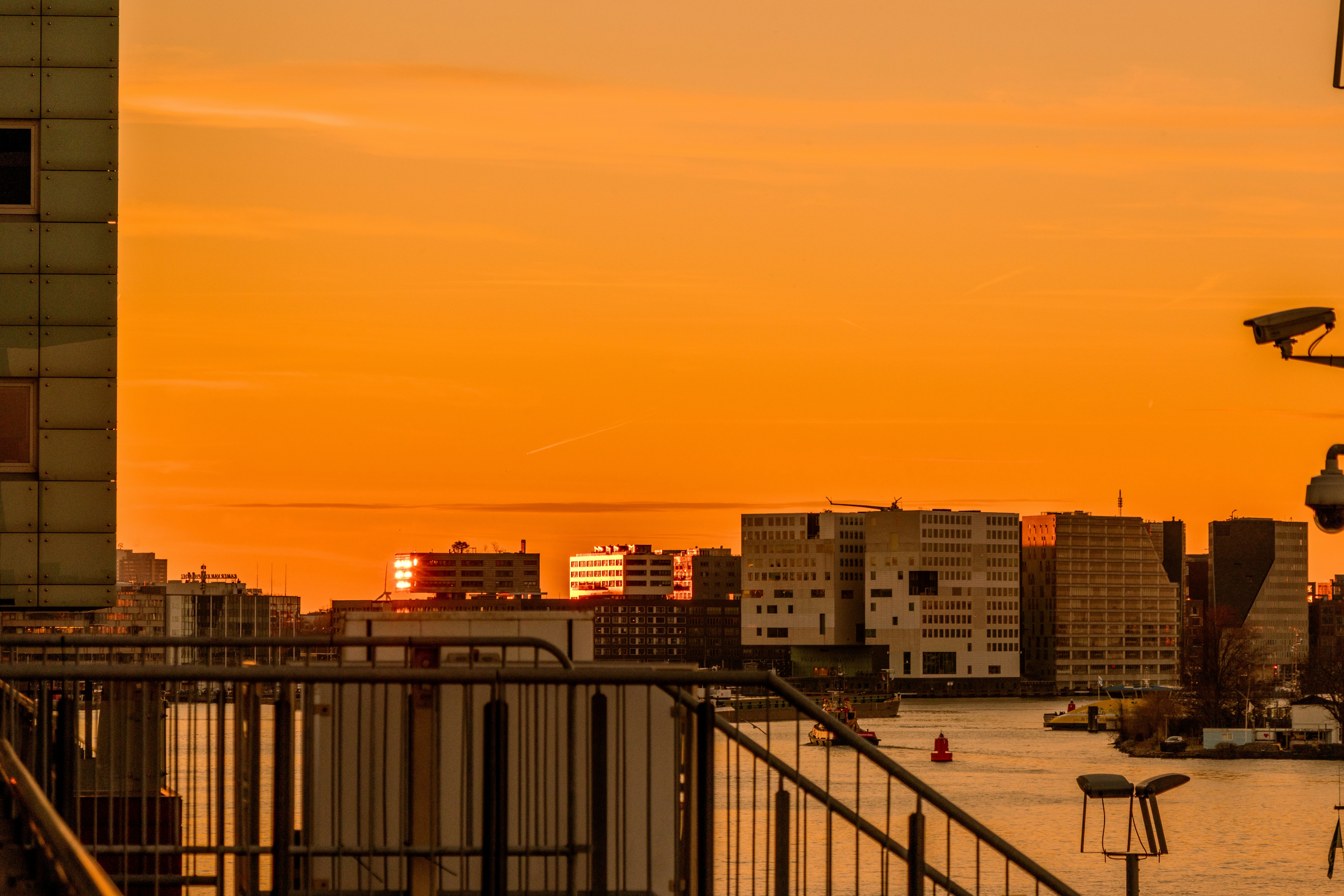 Golden Hour Over the Docks: Sunset Silhouette Above the City