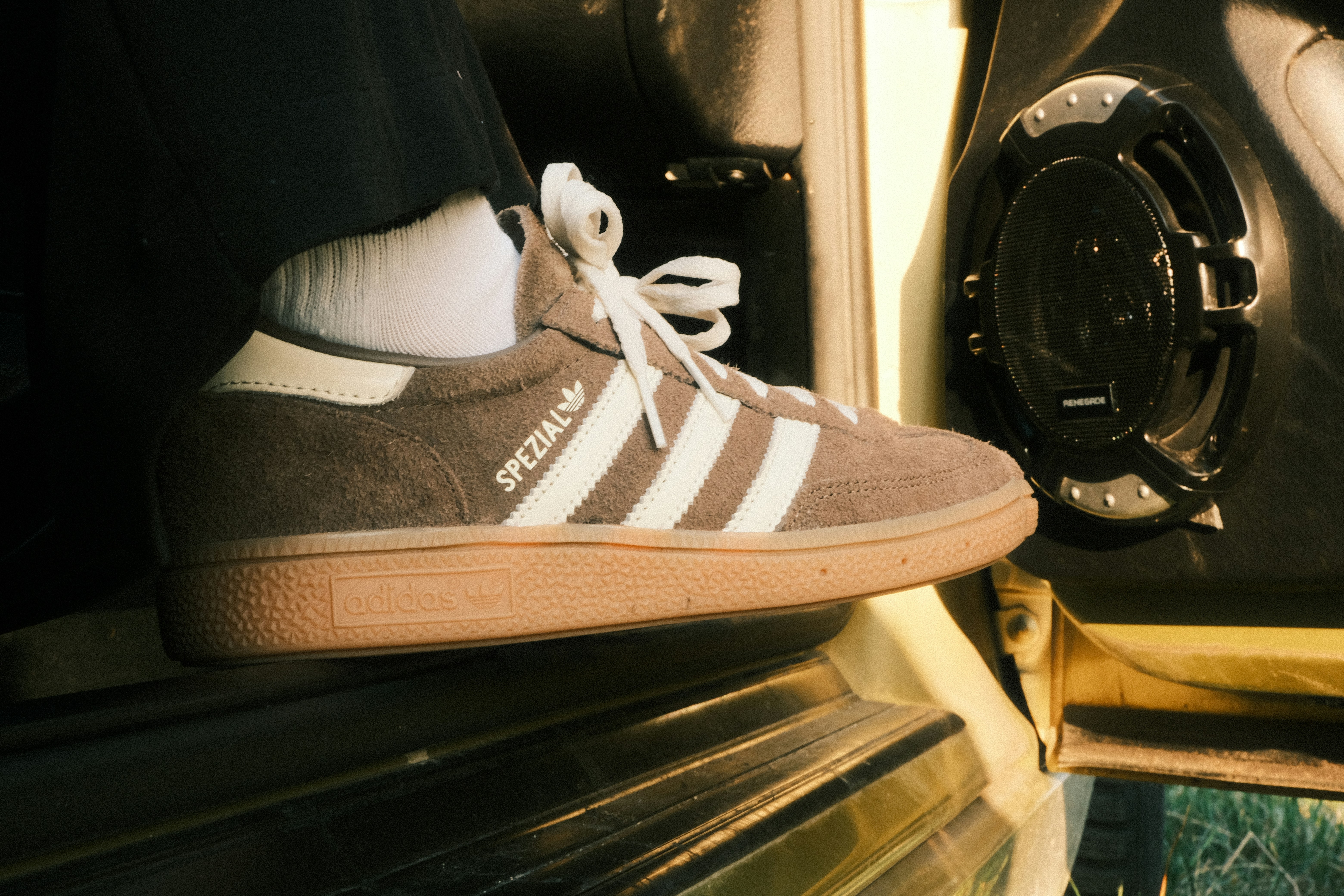 Sneaker on the Threshold: Abrasive Brown Sole Meet Car Interior Light