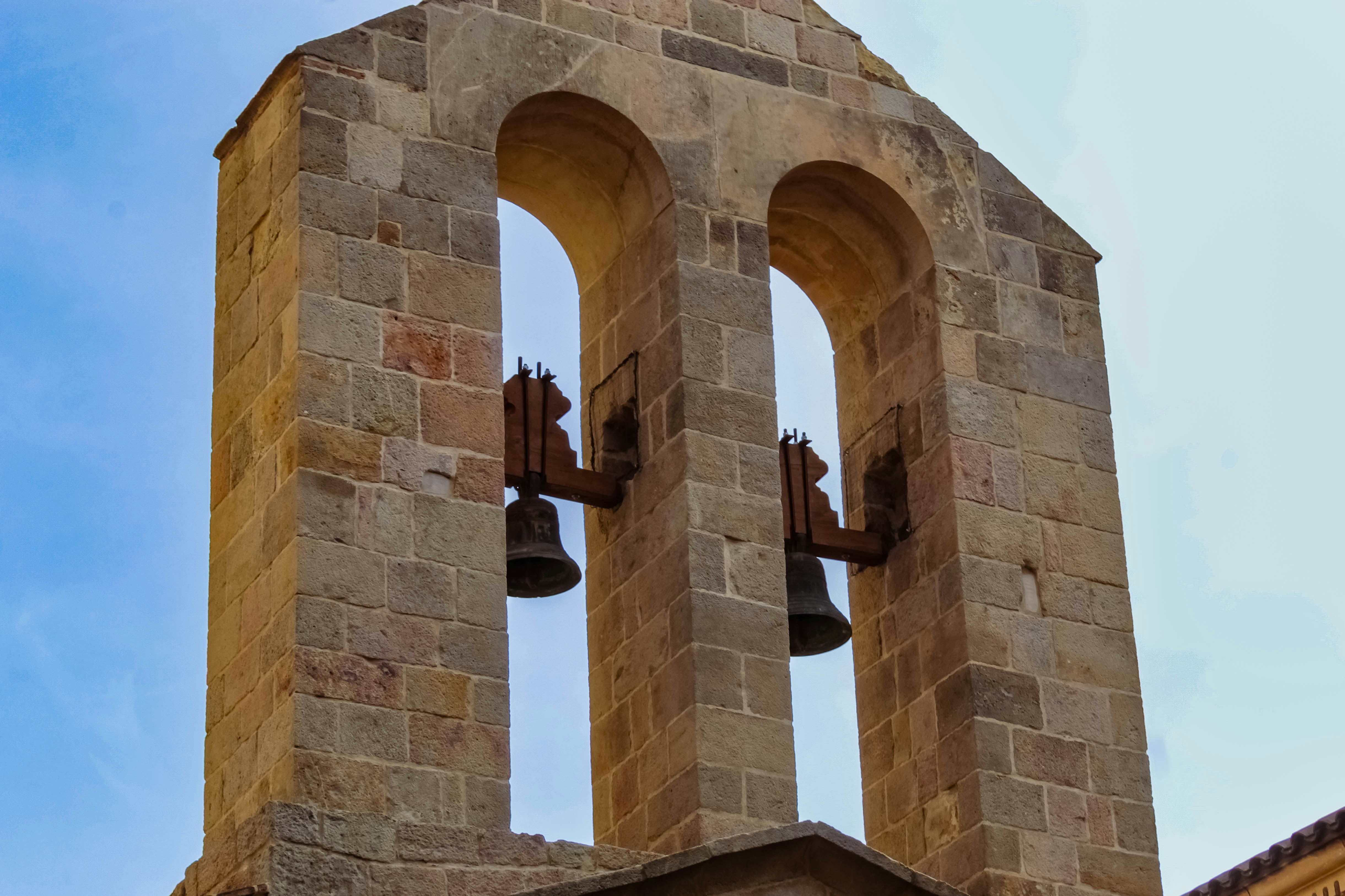 Stone Bell Tower Reaching Toward a Blue Sky