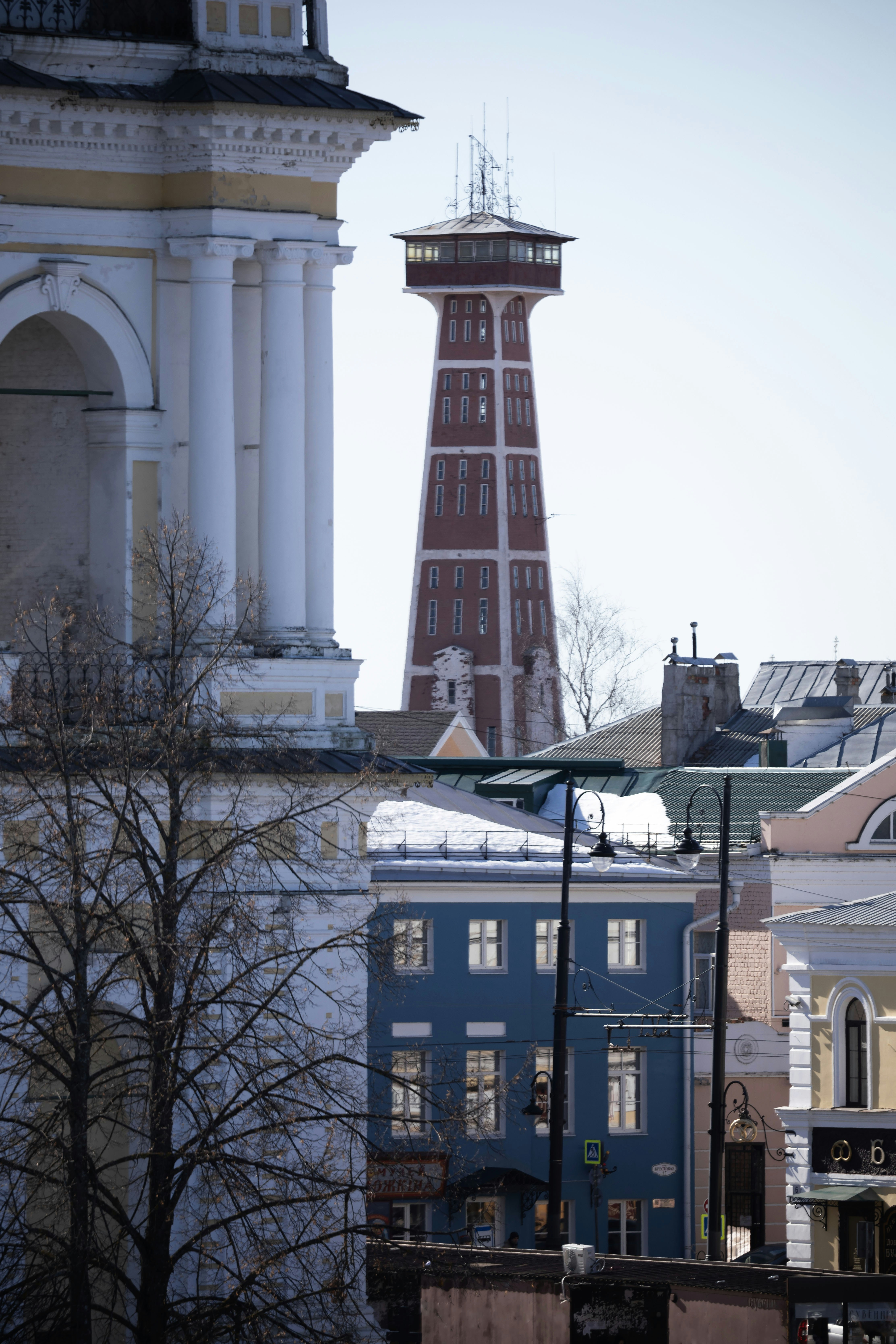 Towered Quiet: A Victorian Street Framed by a Red Brick Spire