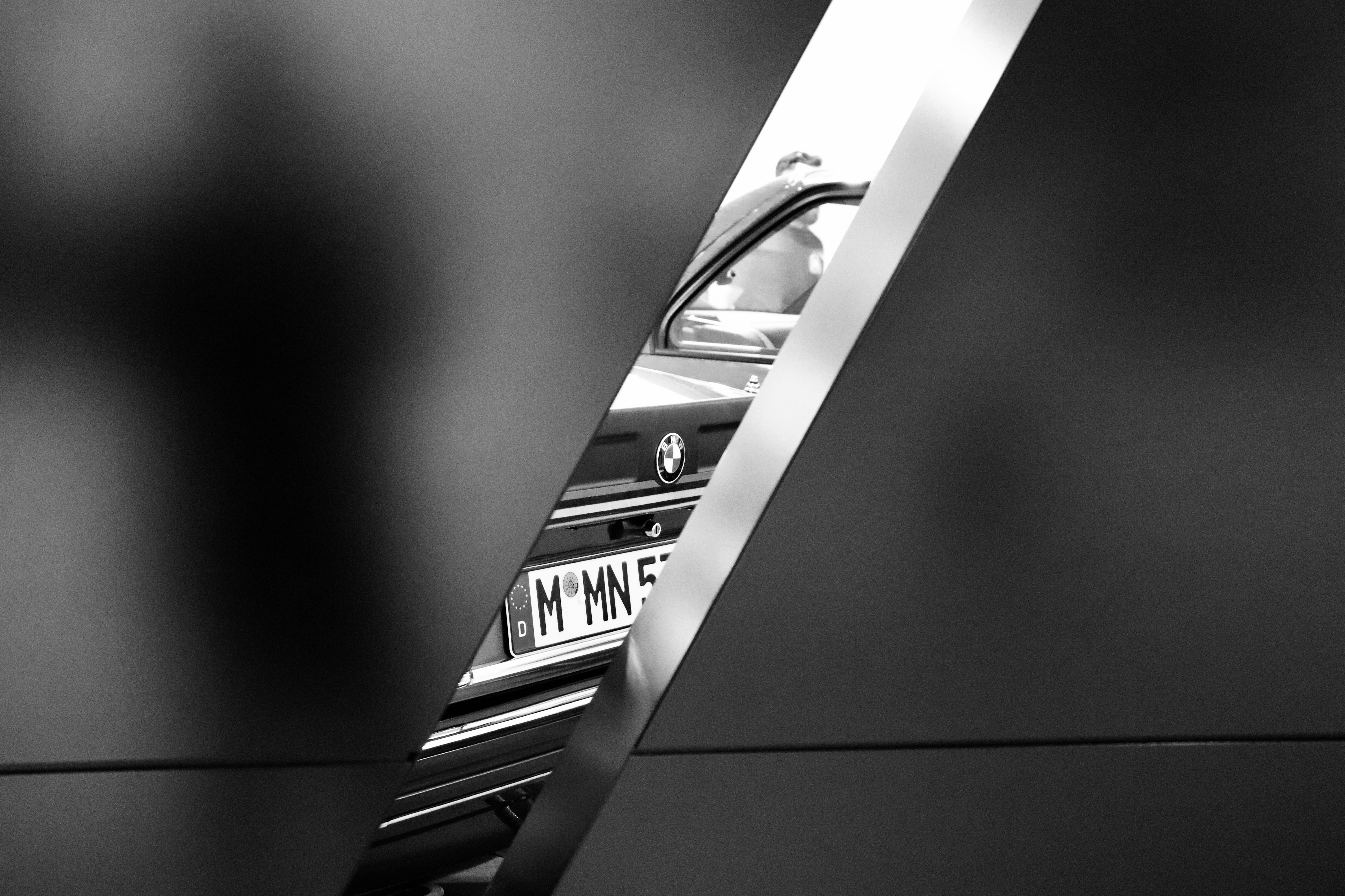 Car Hood Reflections: A Slashed Glimpse Through a Narrow Gap