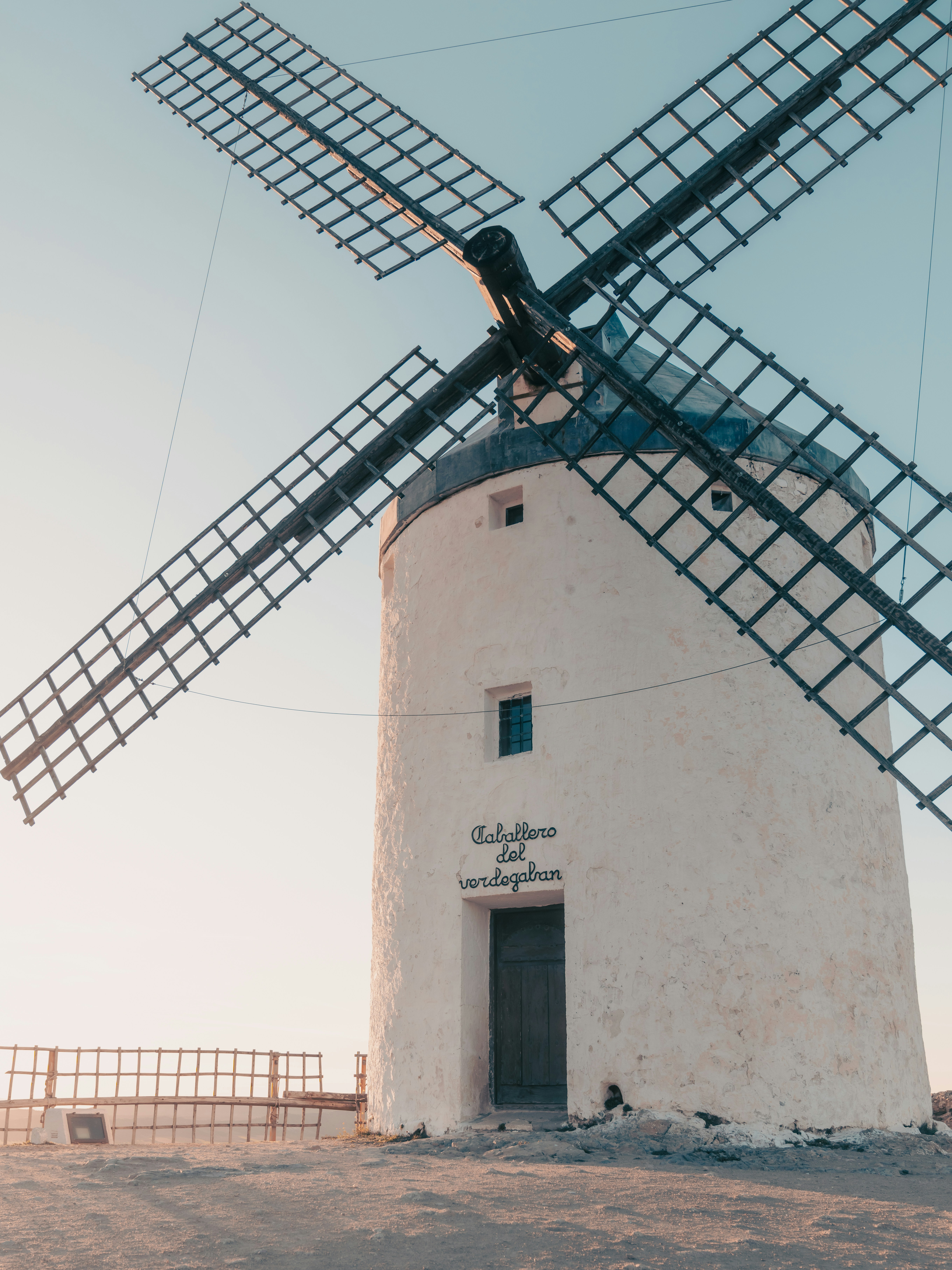 Windmill Sentinel at Dusk: White Tower with Crossing Blades
