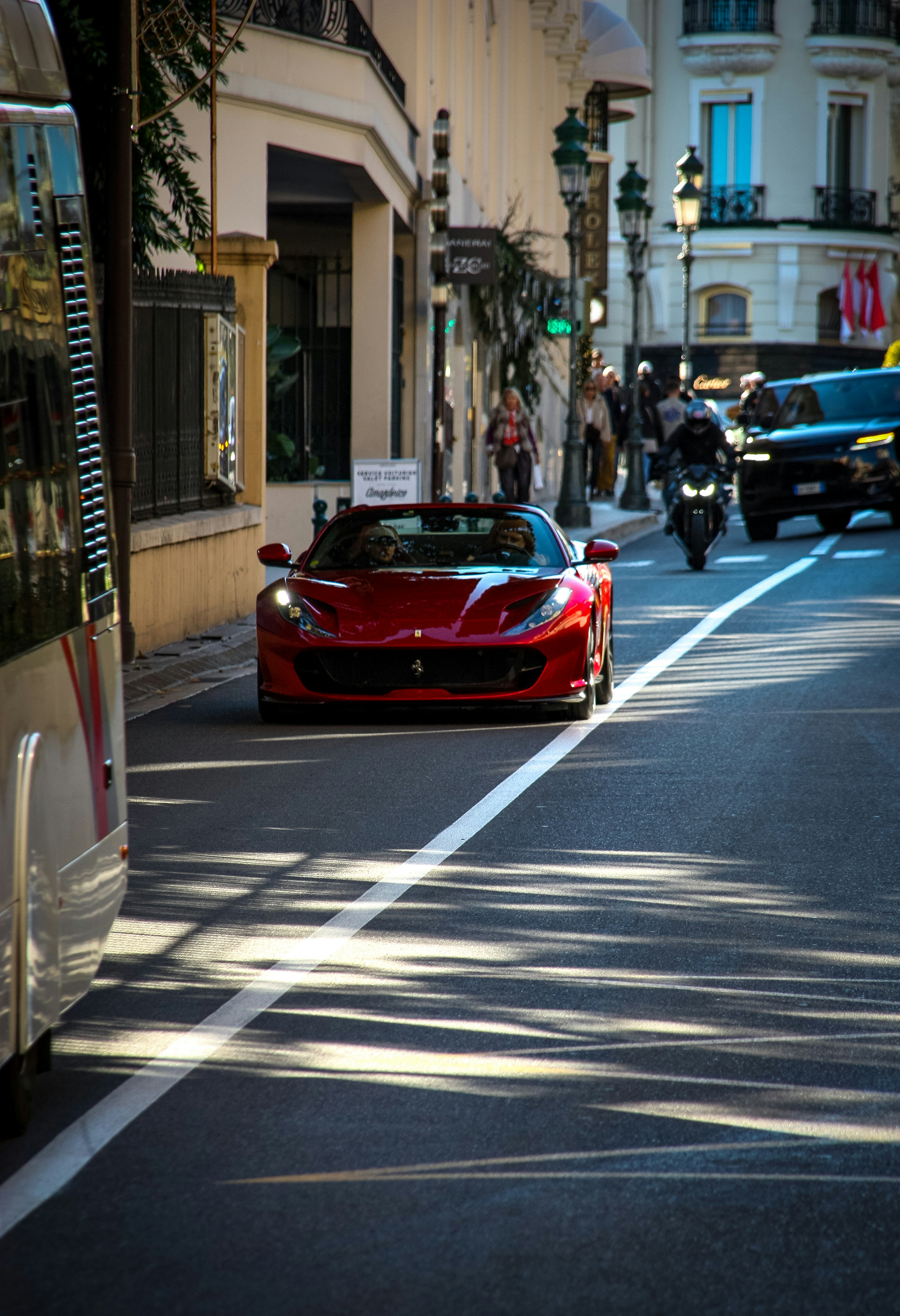 Red Ferrari on a sunlit Parisian Street