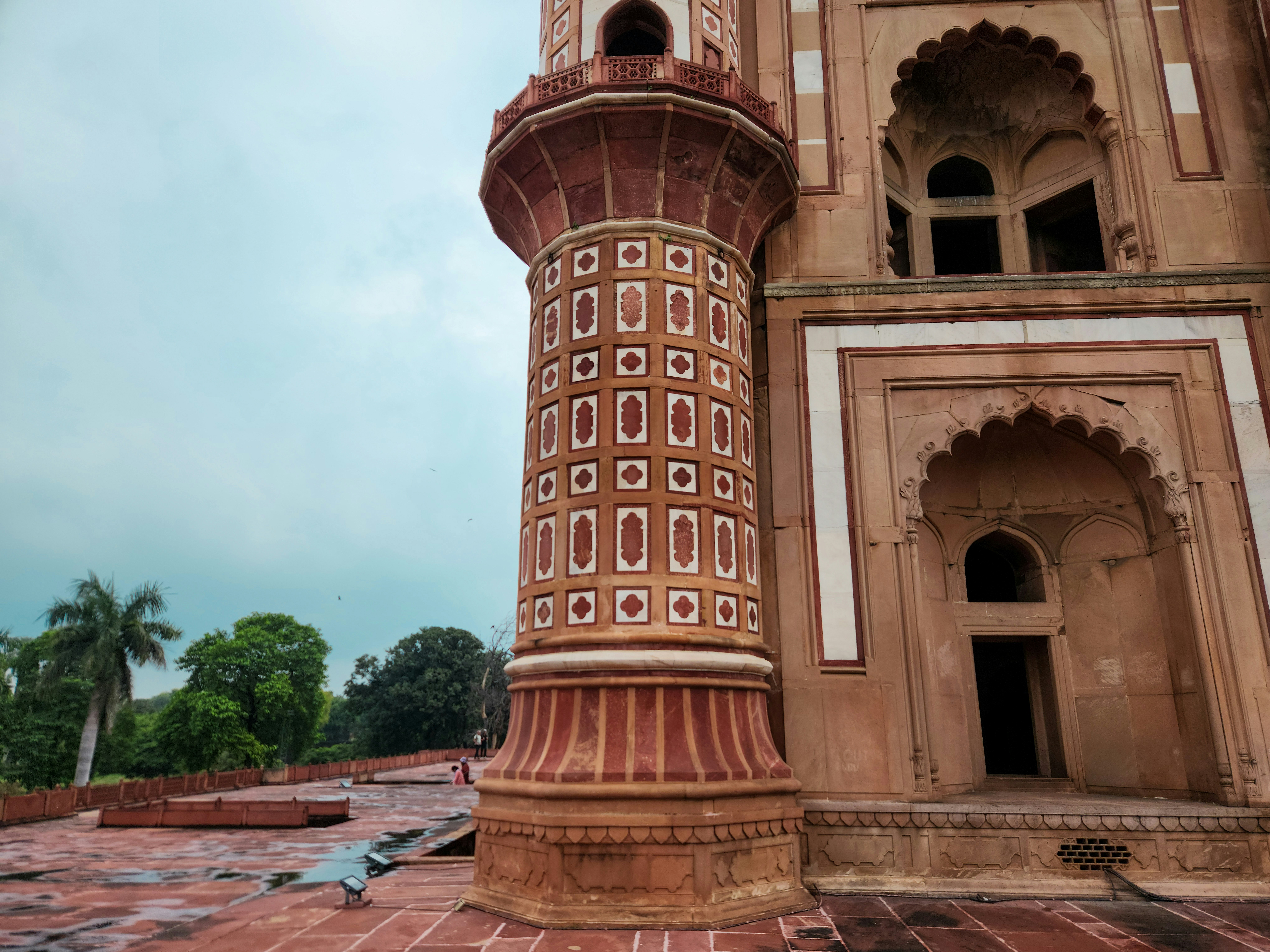 Architectural Column and Arched Entrance: A Monumental Detail in Red Sandstone