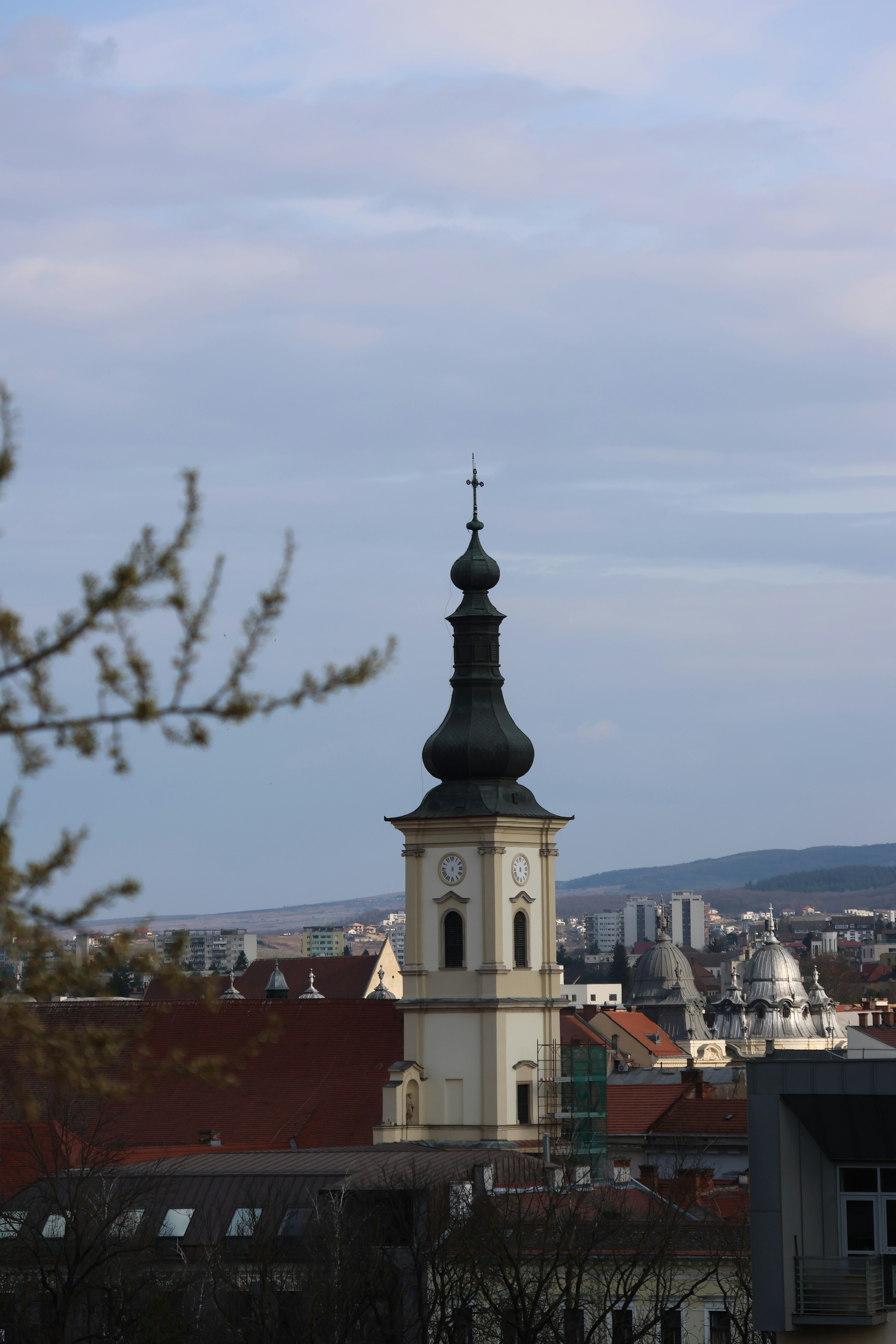 City Clock Tower Rising Above Rooftops at Dusk