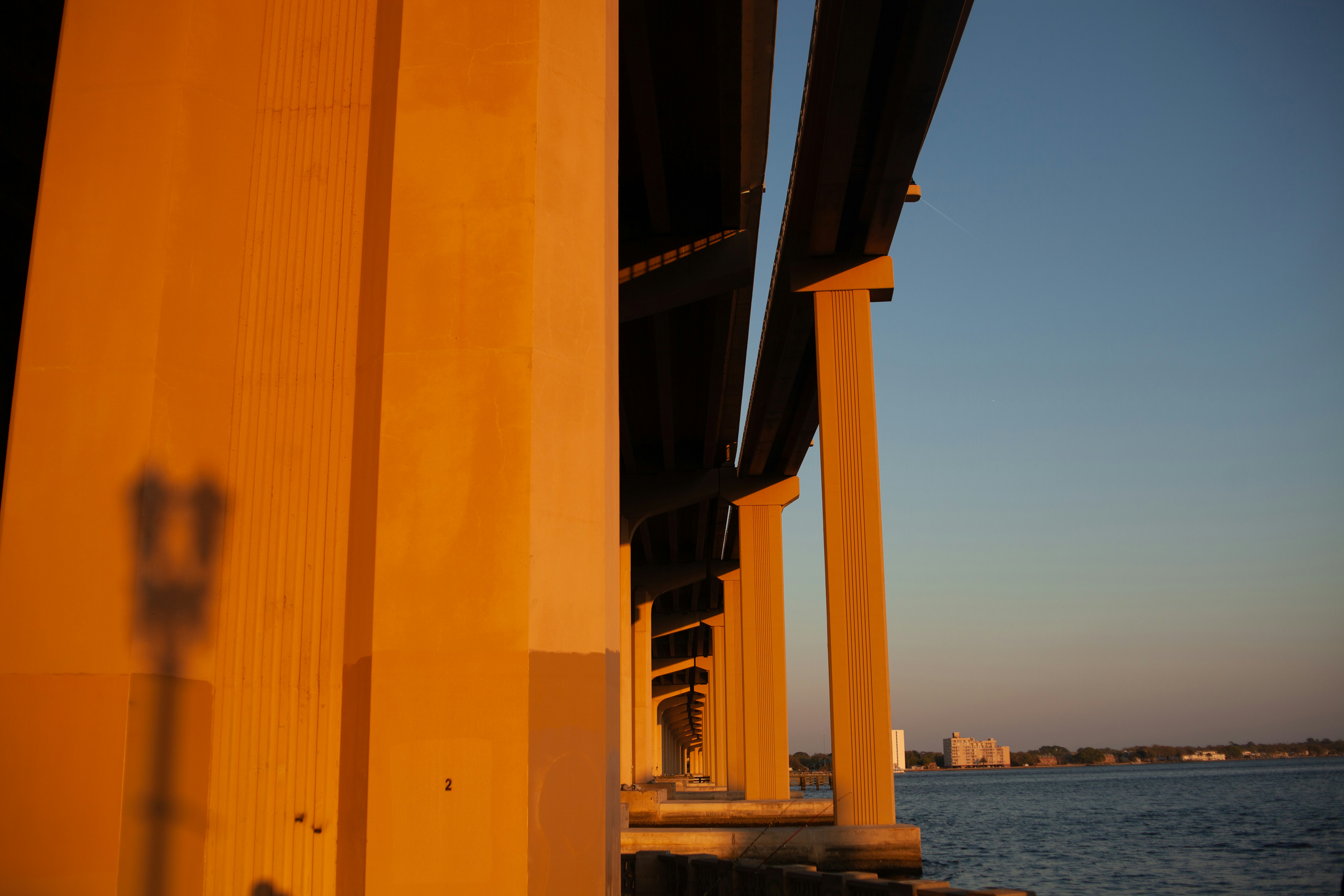 Golden Bridge Columns: Echoes of Light Along the Waterfront