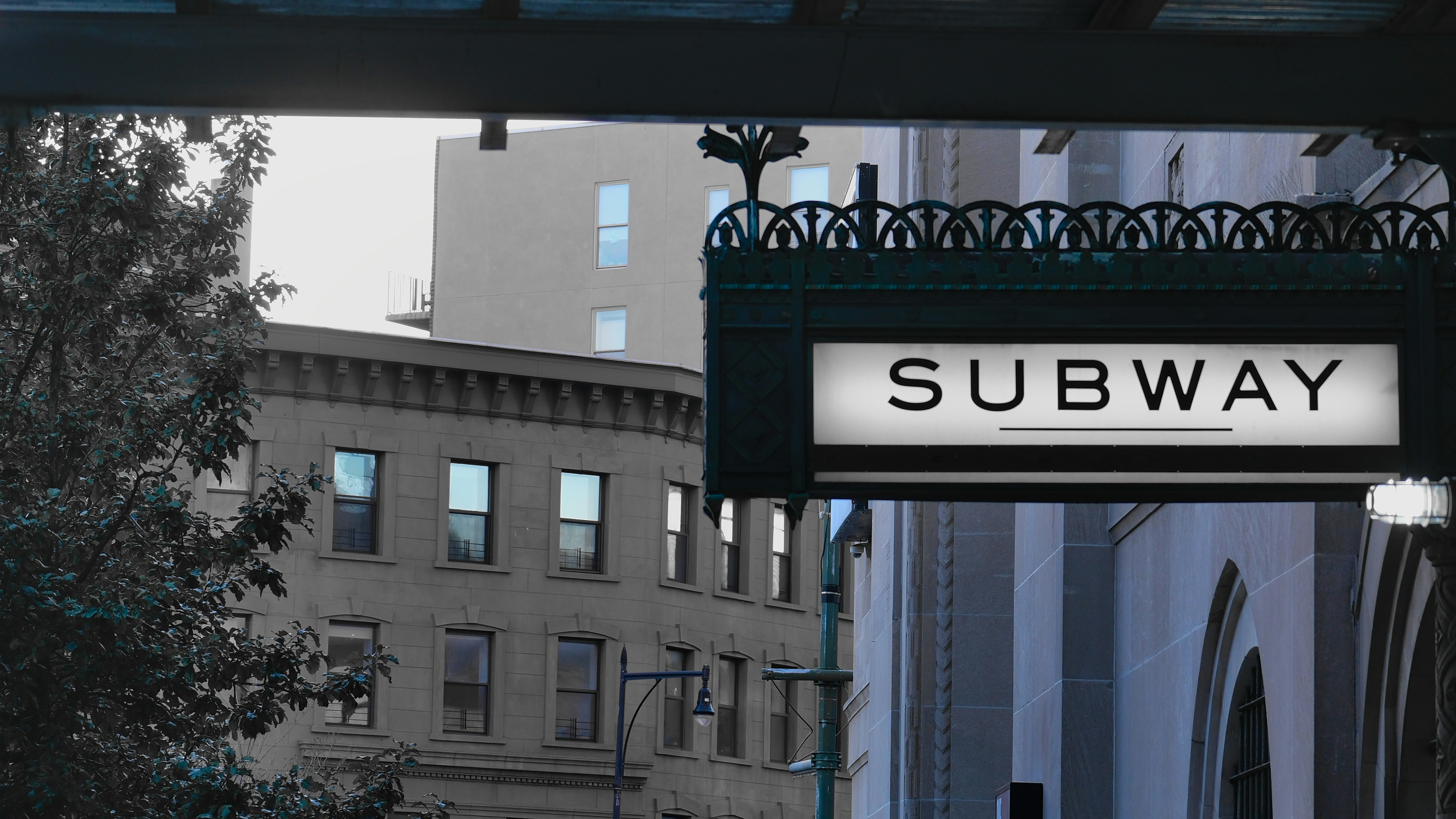 Urban Portal: The Subterranean Sign Looming Over a Quiet Street