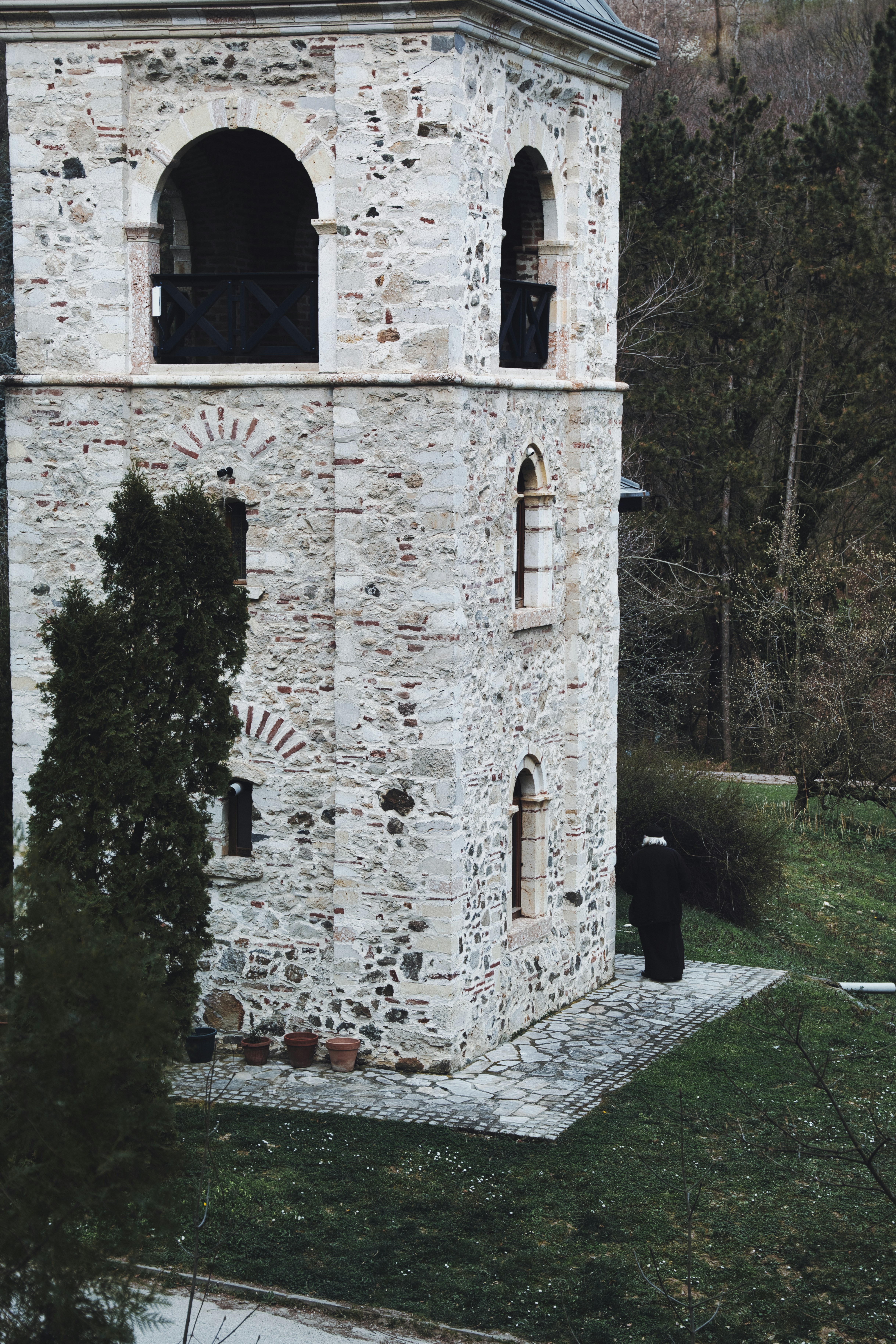 Stone Bell Tower with Shaded Balcony and Silent Visitor