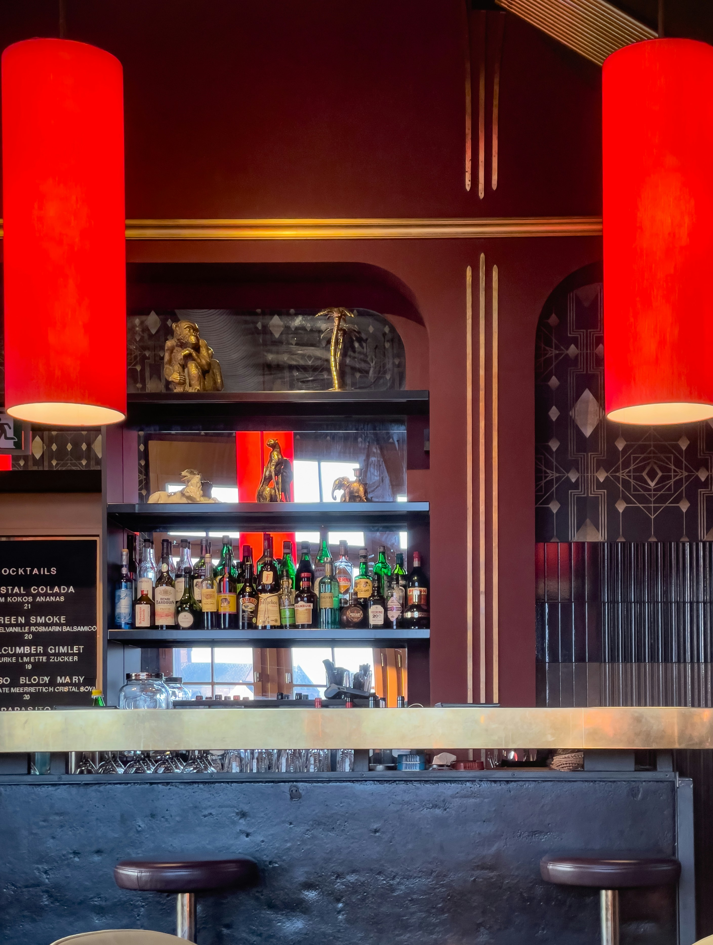 Red Lanterns Over a Bar: Neon Contrast and Shadowed Shelves