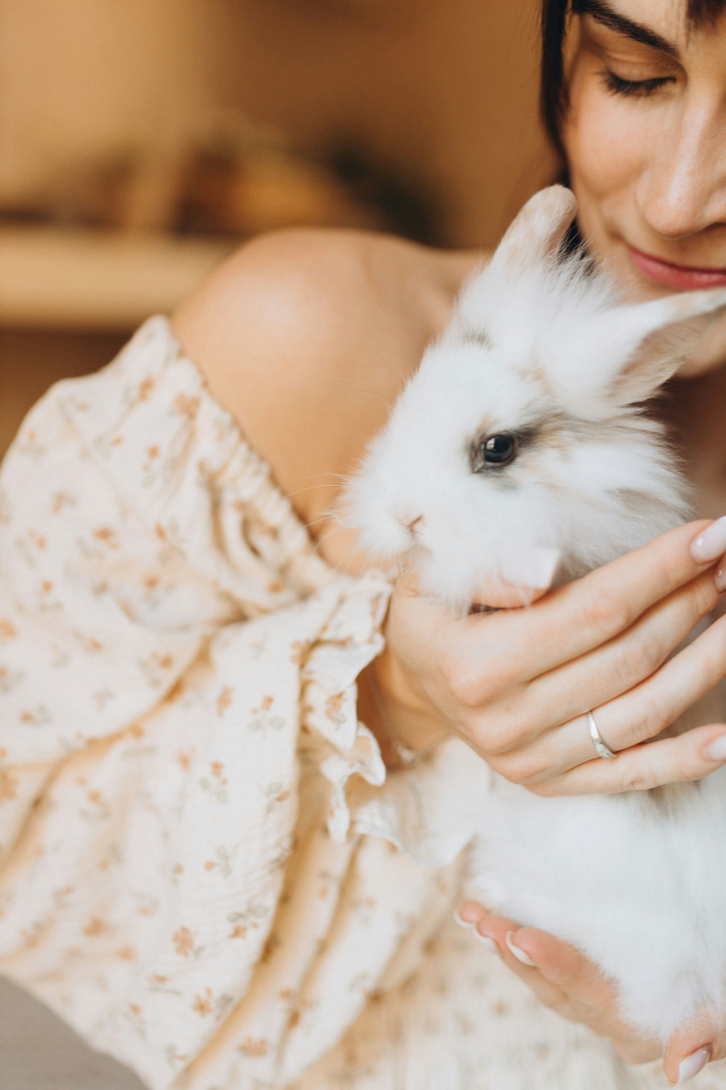 Soft Moment: A Woman's Gentle Hold on a White Bunny