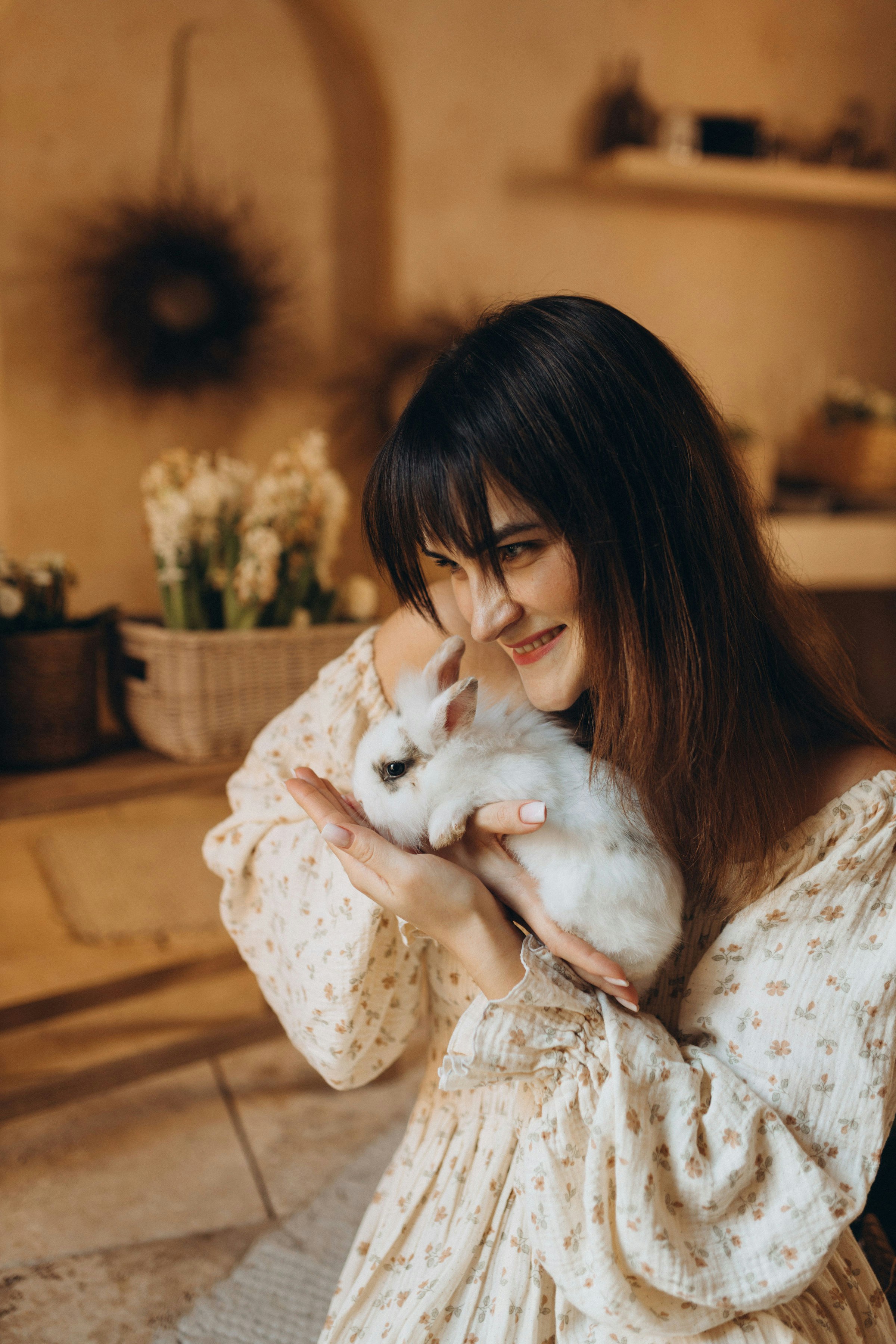 Soft Embrace: A Woman and Her White Rabbit in Warm Light