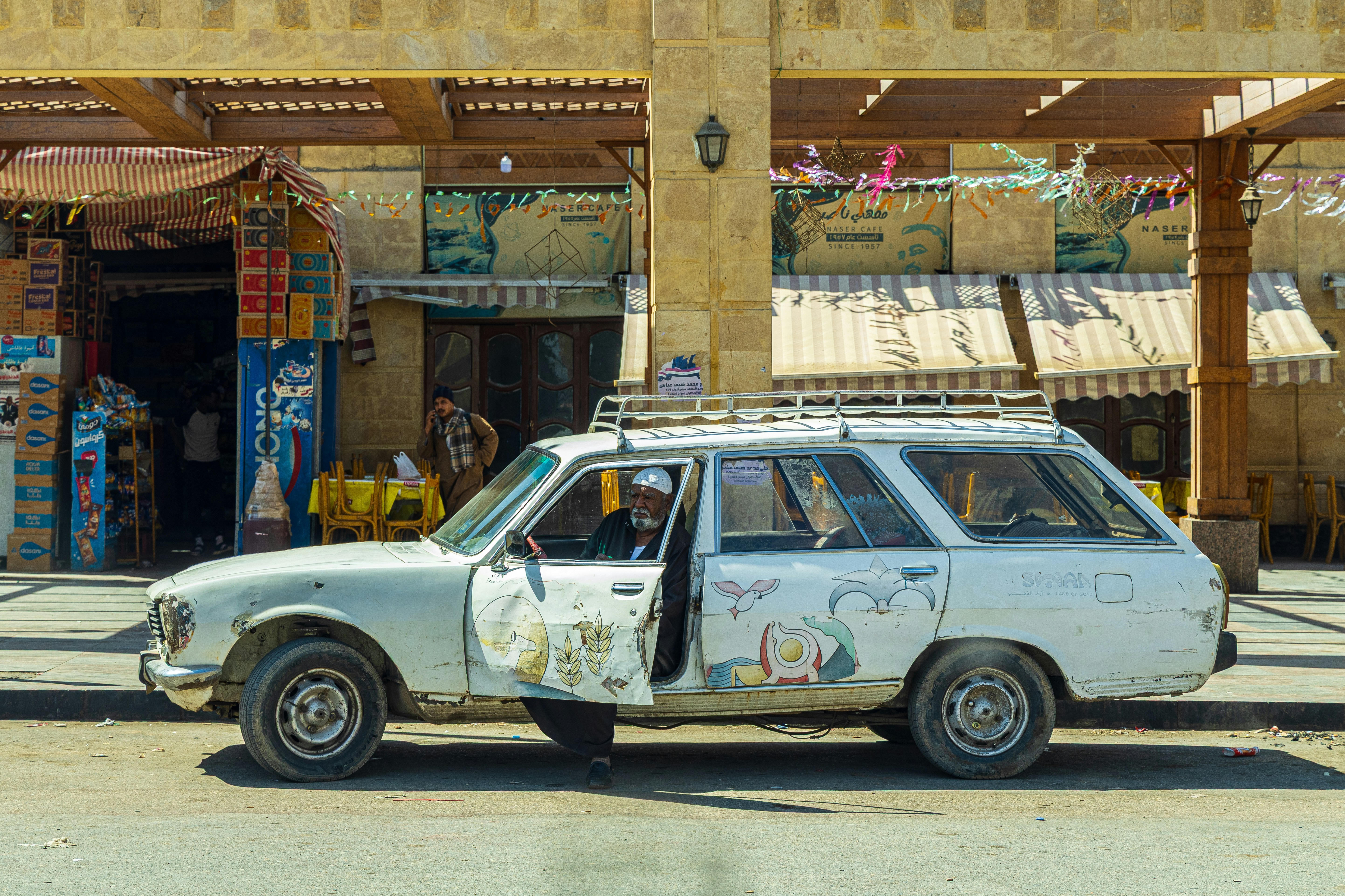 Dusty Station Wagon: A Street portrait of a man stepping from a vintage ride