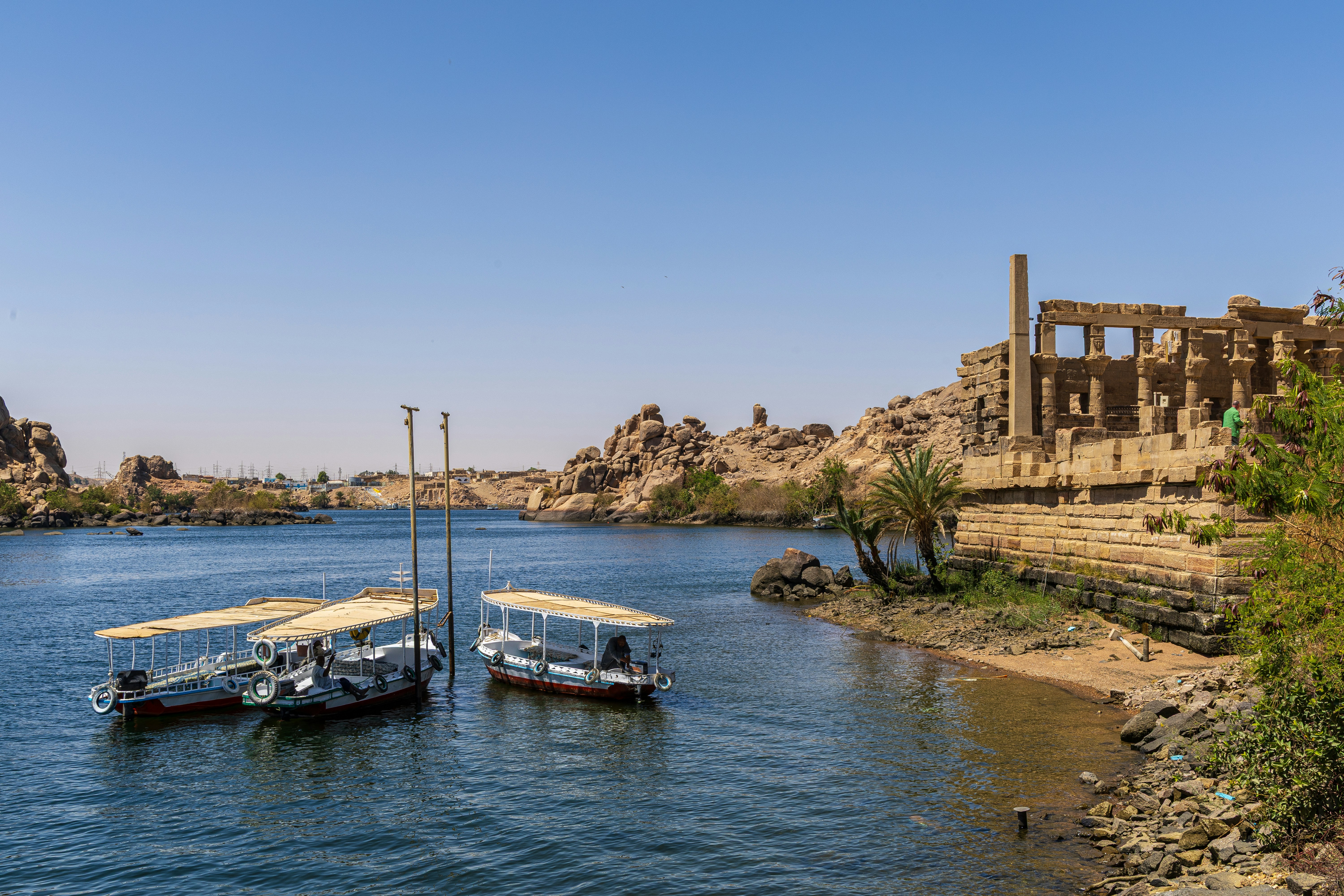 Ruins by the River: Historic Structure Framing a Tranquil Dock