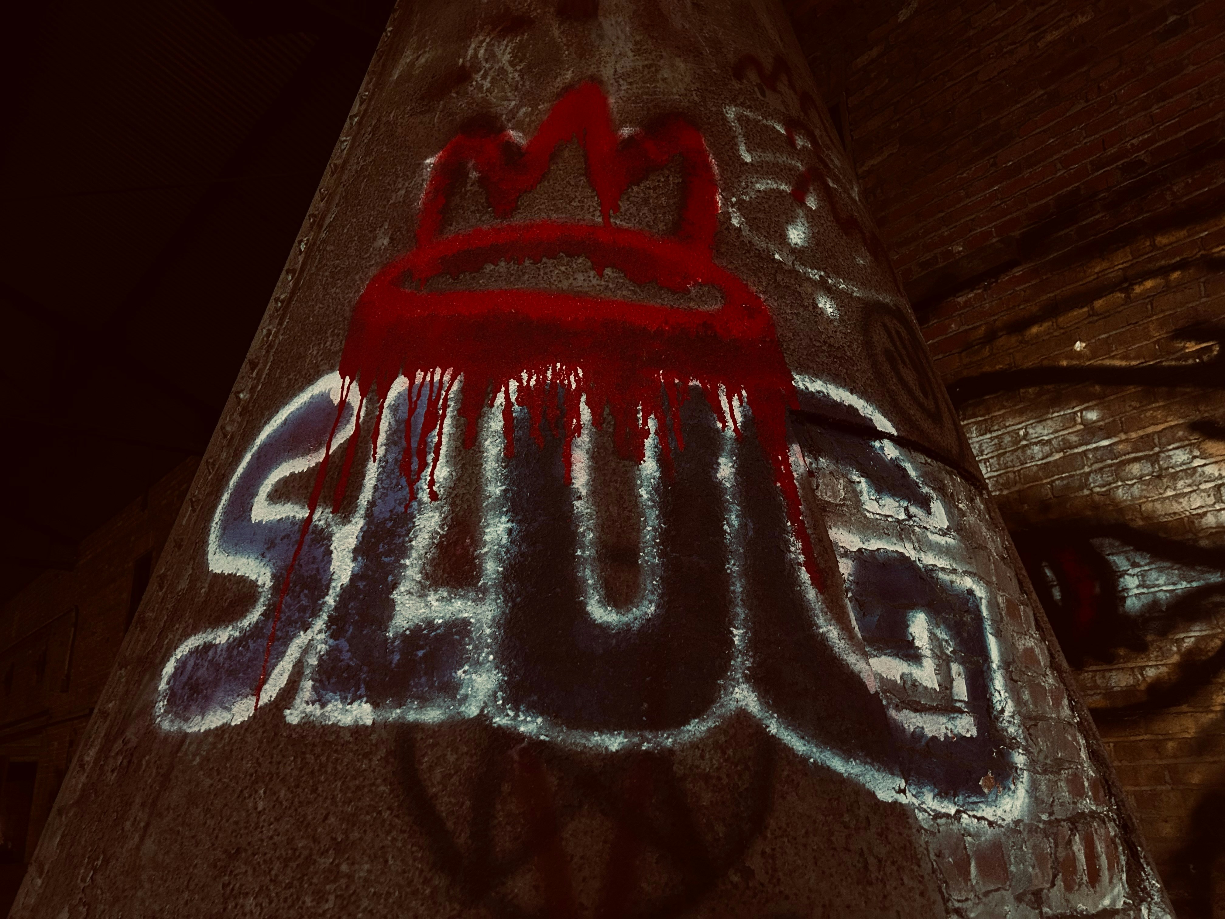 Red Crowned Chalk Graffiti on Weathered Wood